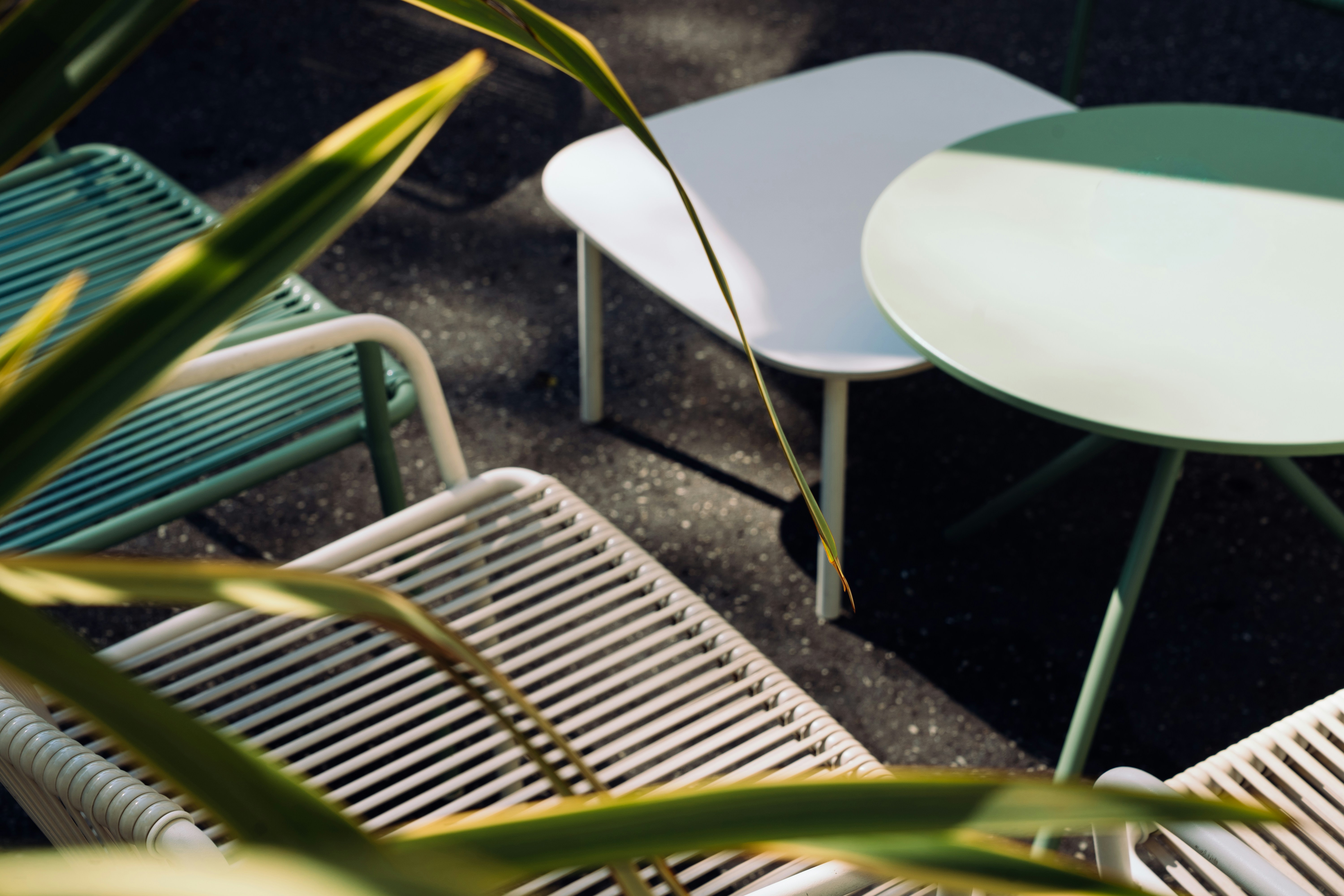 Muted Geometry: Outdoor Tables in Soft Focus Shadows