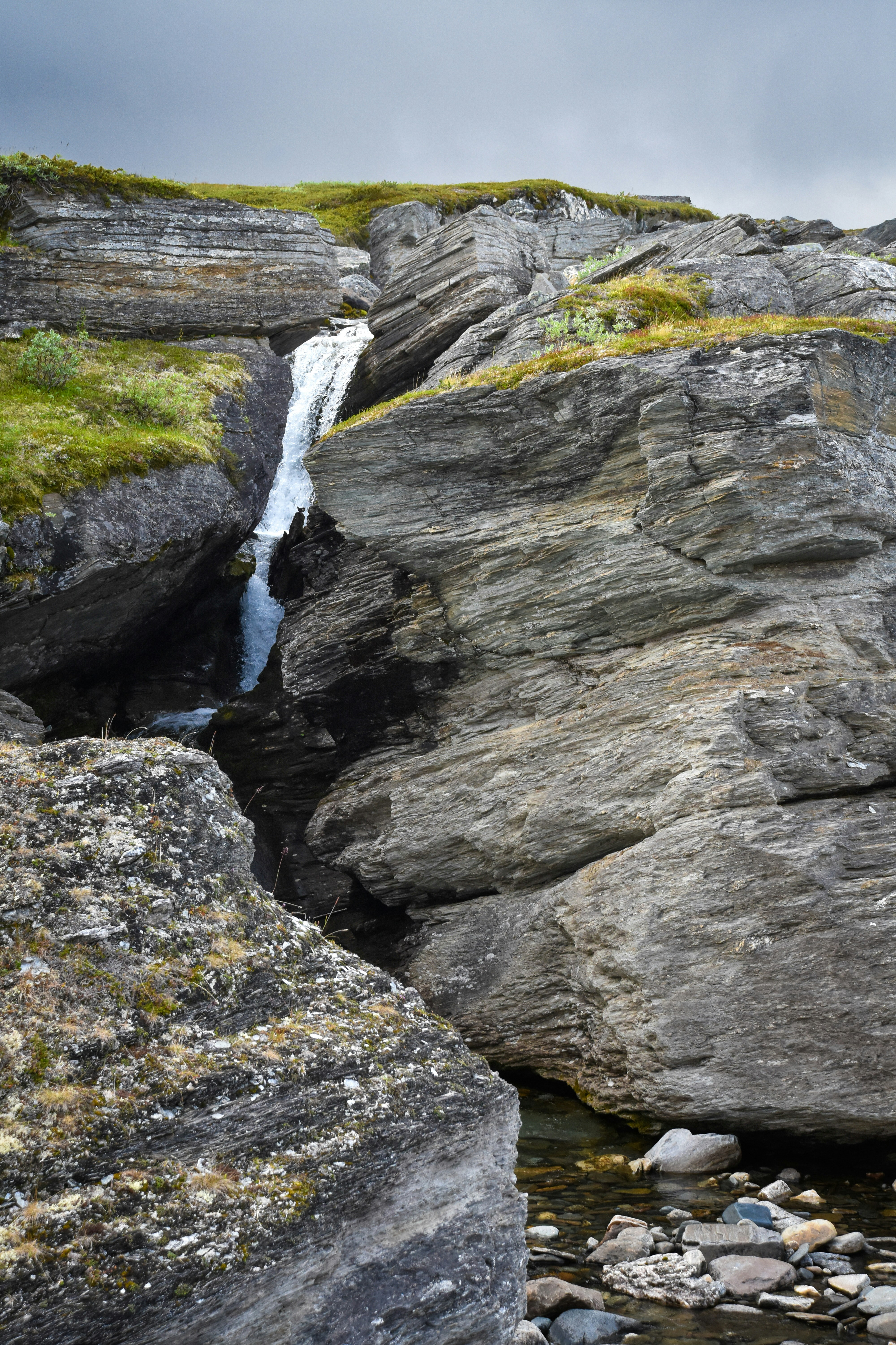 Rugged Cascade Between Weathered Cliffs