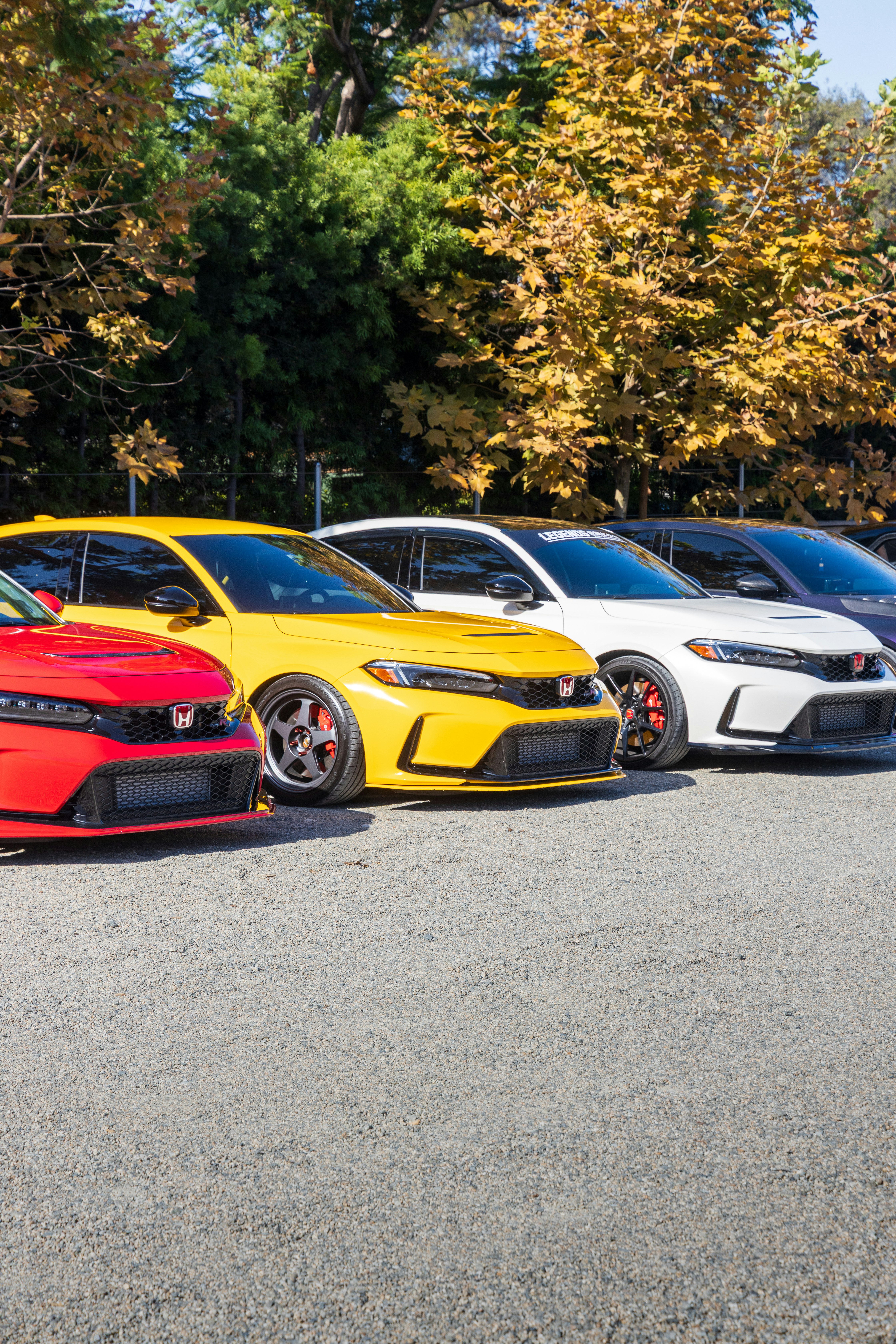 Colorful lineup: a trio of tuned hatches parked in a sunlit lot