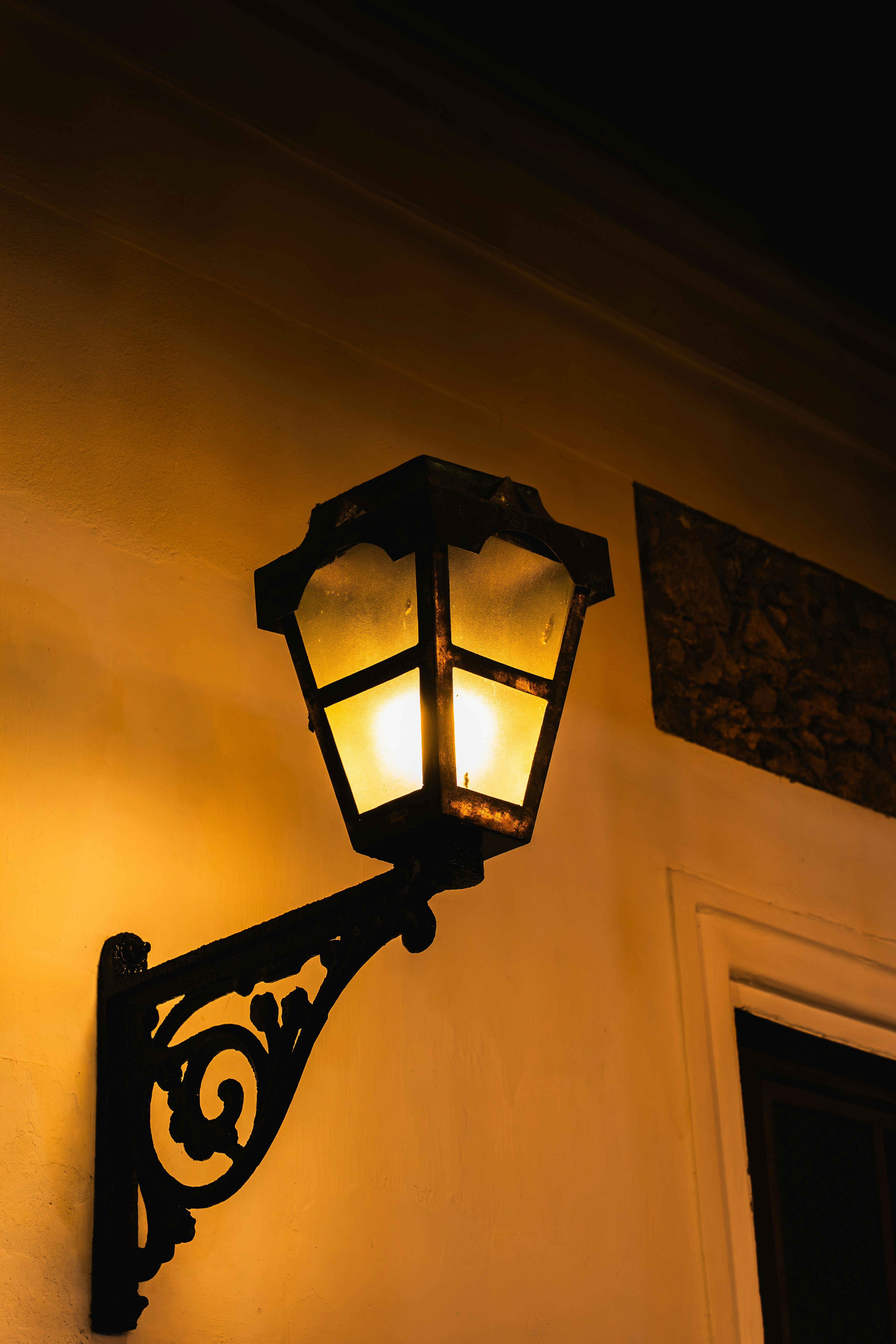 Night Glow: An Ornate Exterior Lantern Casting Warm Light