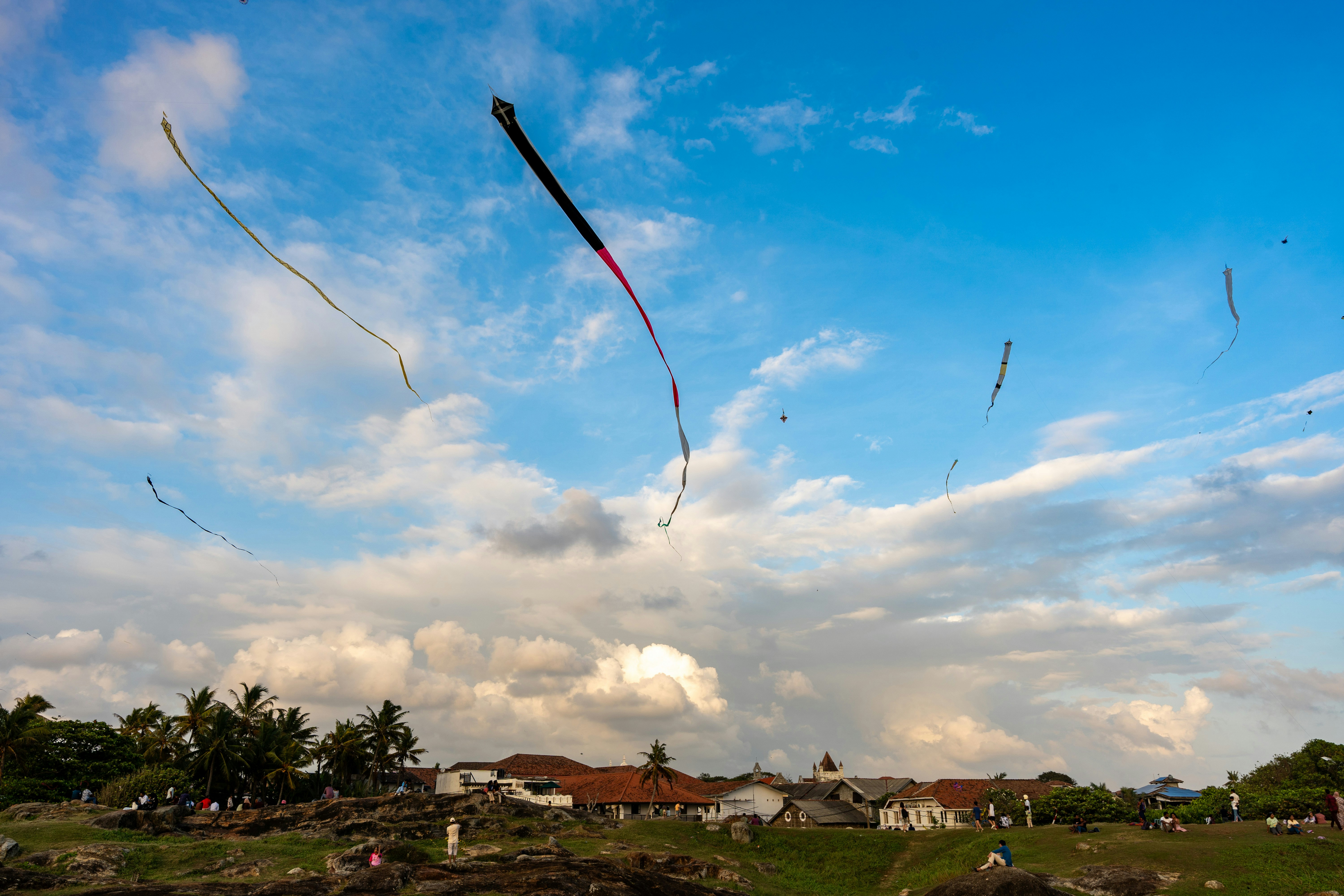 Kite-tailed Sky Over a Coastal Village