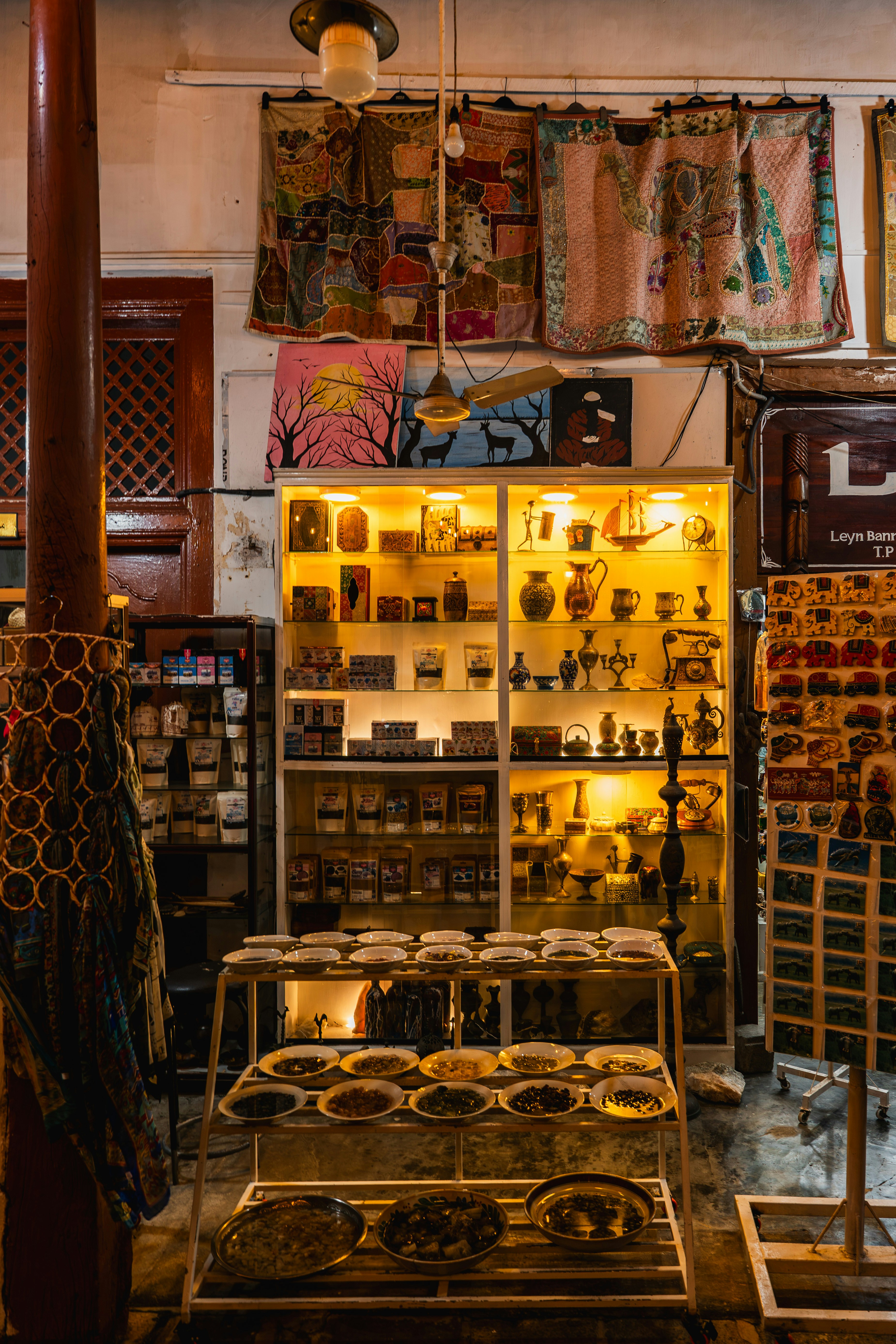 Golden-lit Shop Window: Ceramicware and Antiques in a Cozy Bazaar