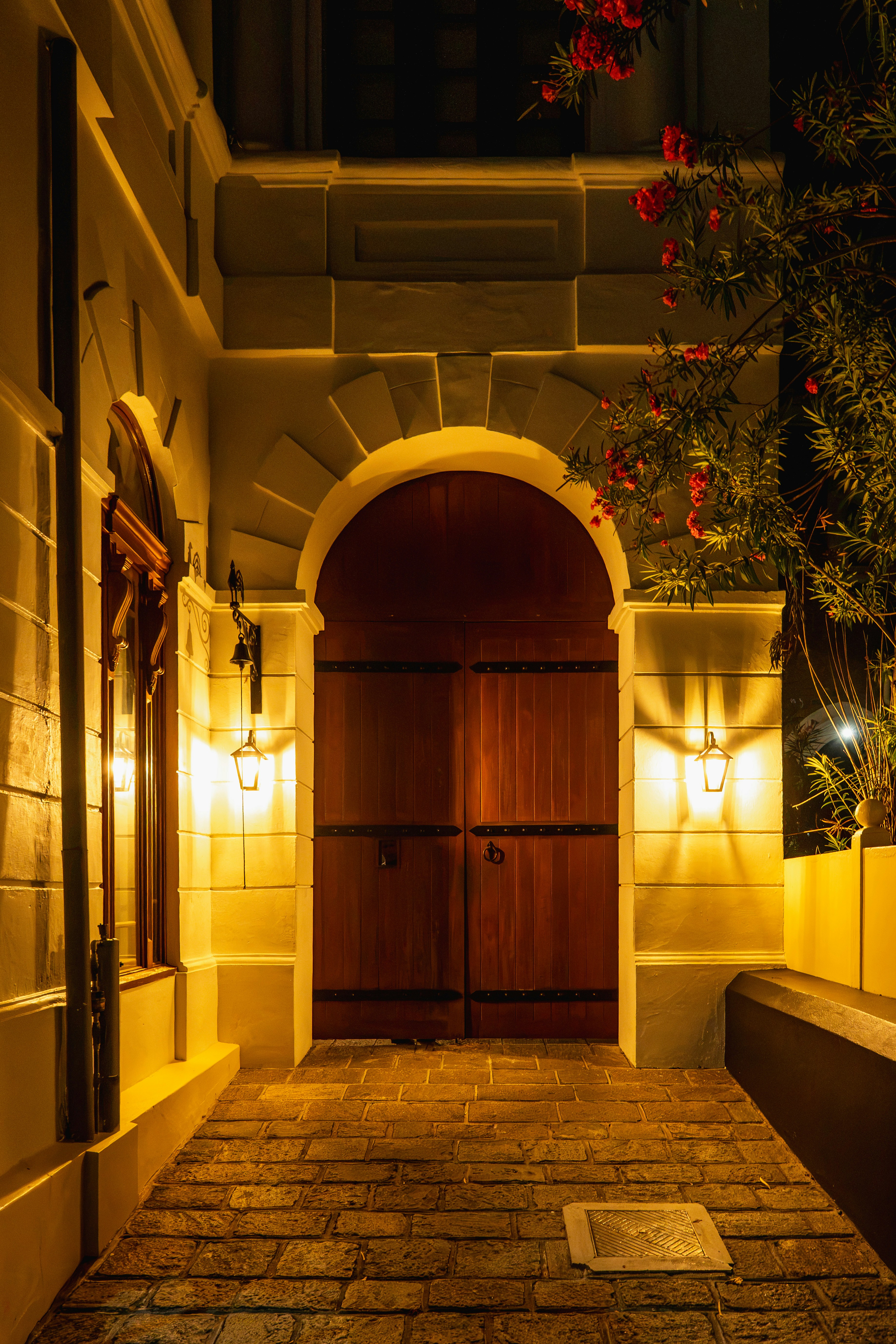 Golden Archway: Night-time Portal to a Quiet Courtyard
