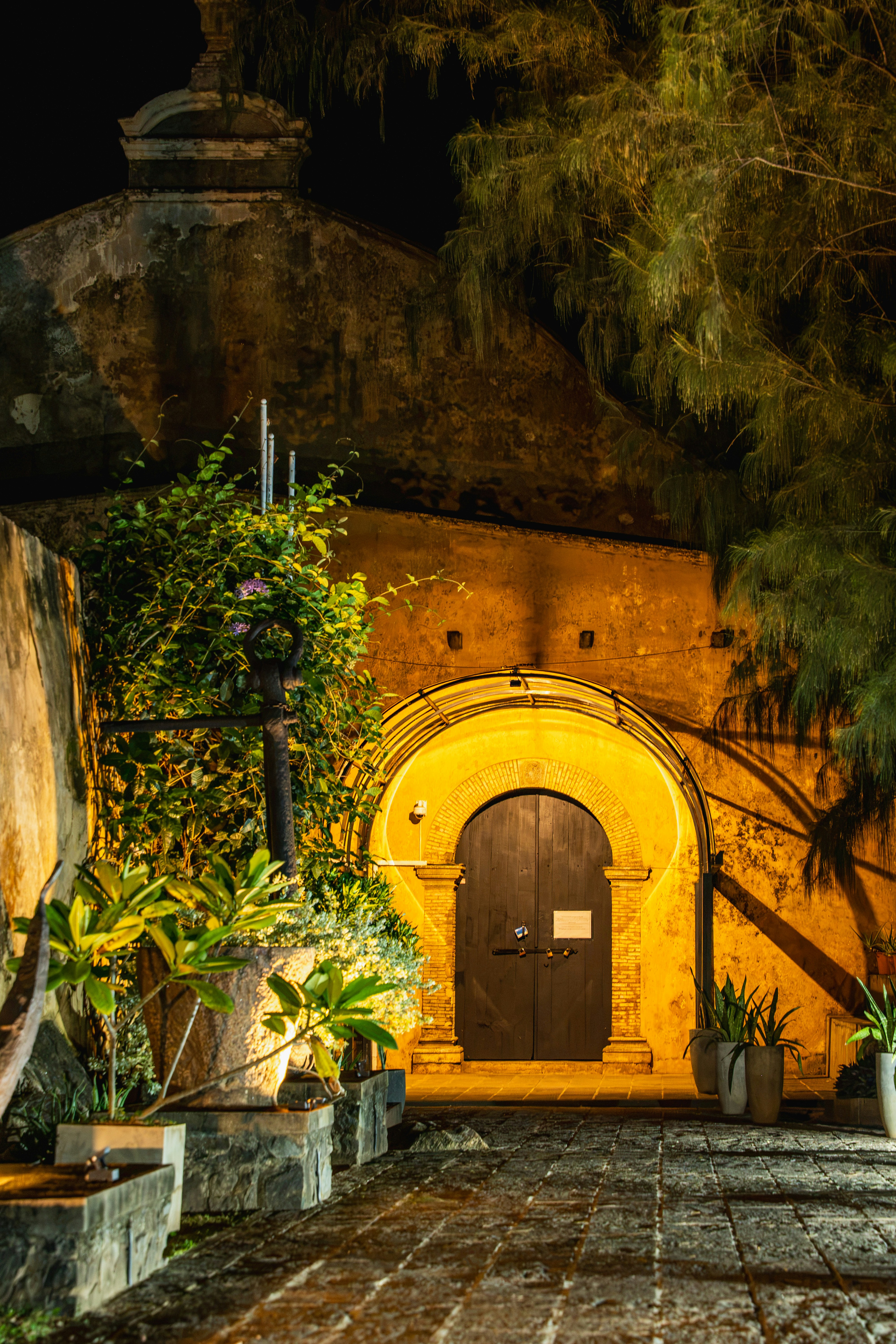 Golden Archway at Night: A Quiet Courtyard Entrance