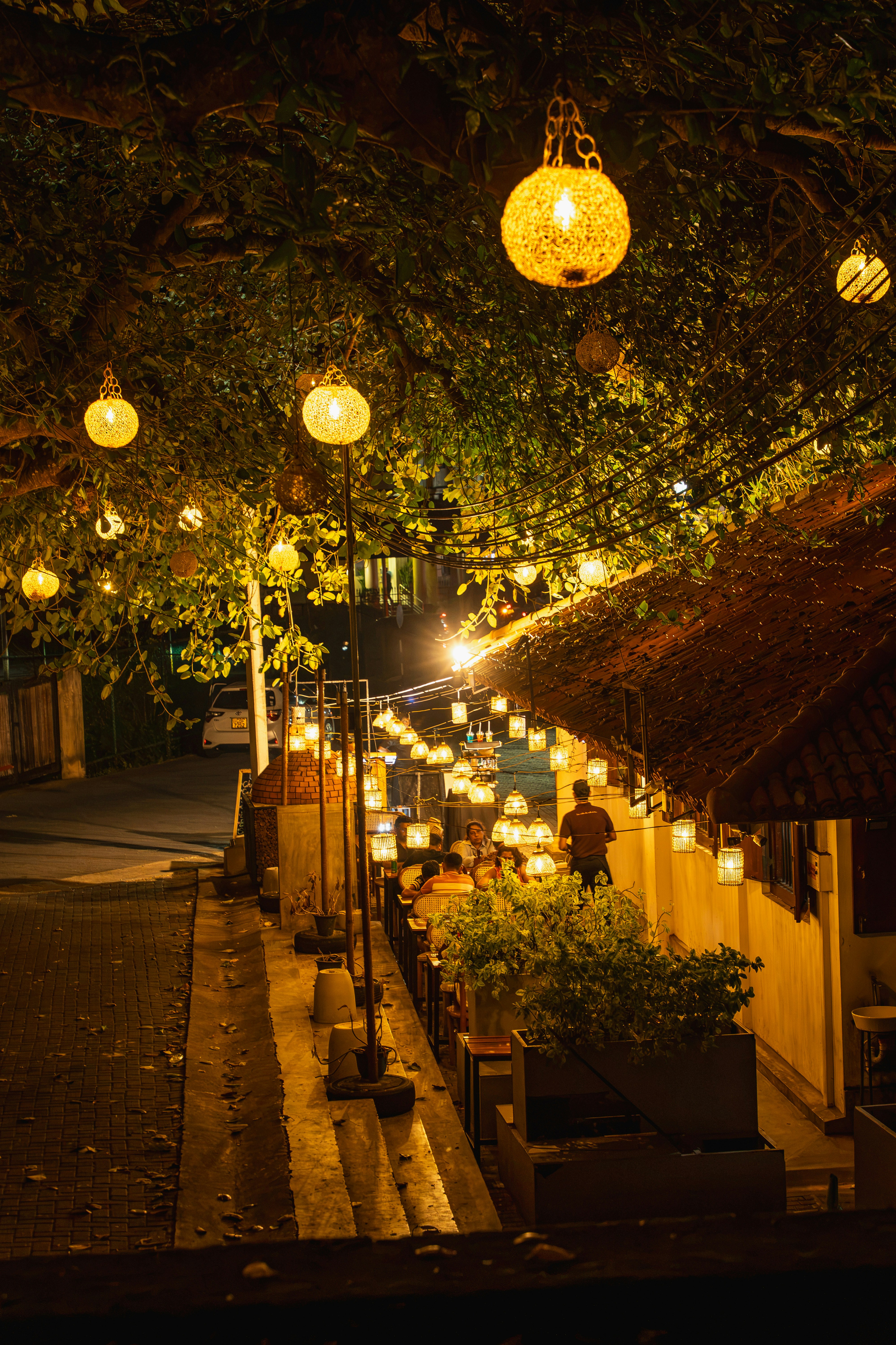 Lantern-lit Lane: Warm Glow Over a Narrow Evening Courtyard