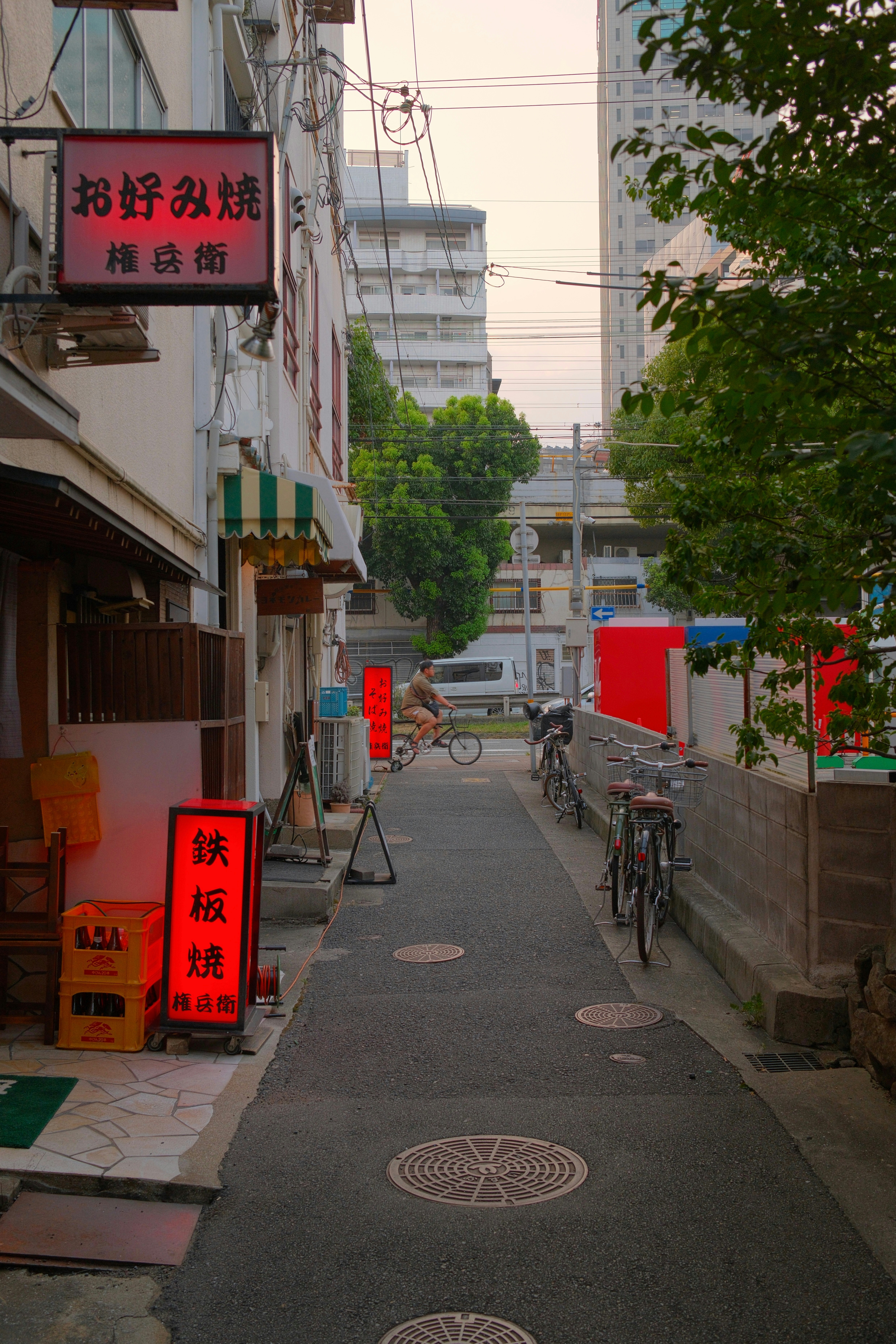 Quiet Alleyway Beneath Neon Signs and Bicycle Racks