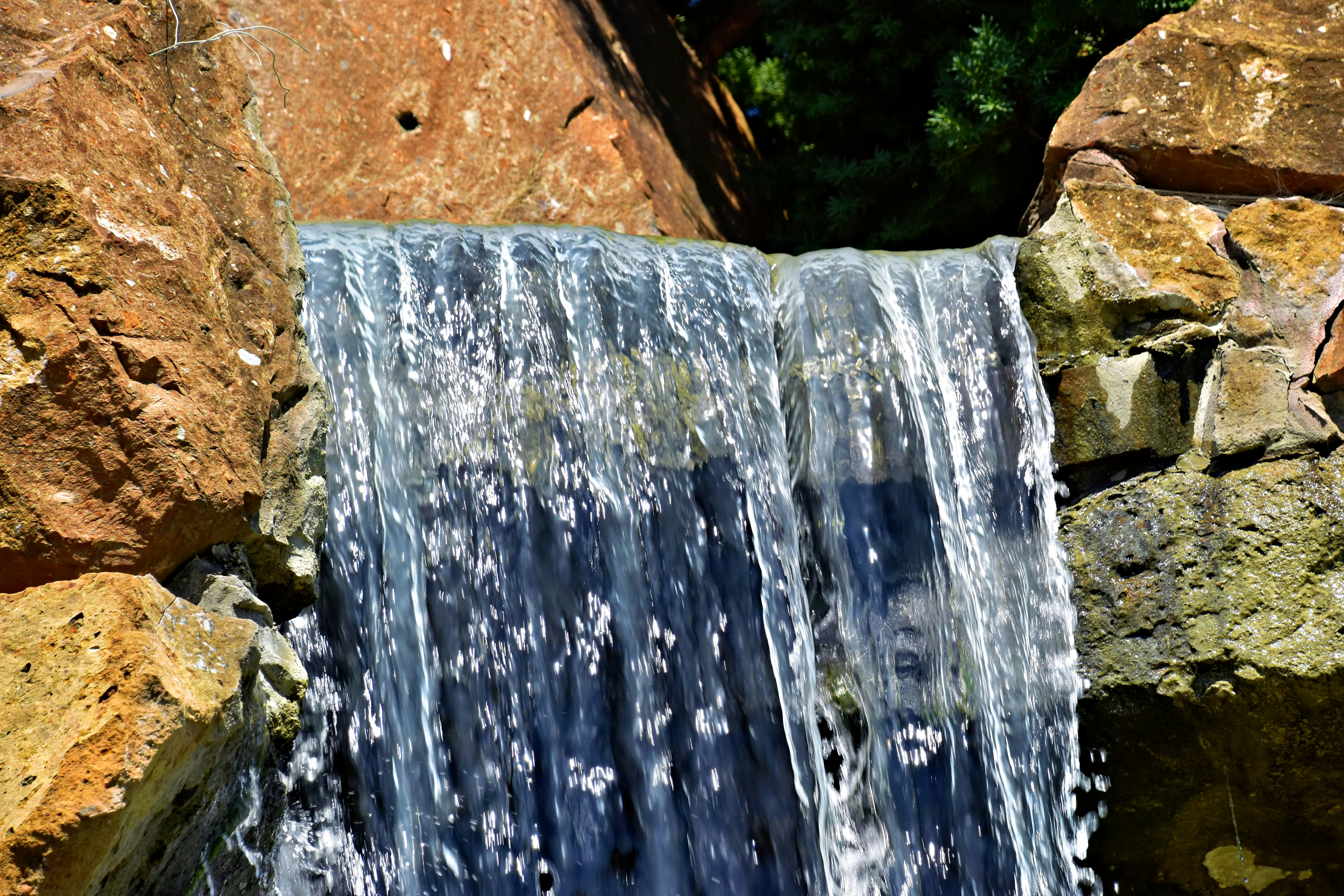Cascade Between Weathered Stones: A Small Waterfall in a Rocky Channel