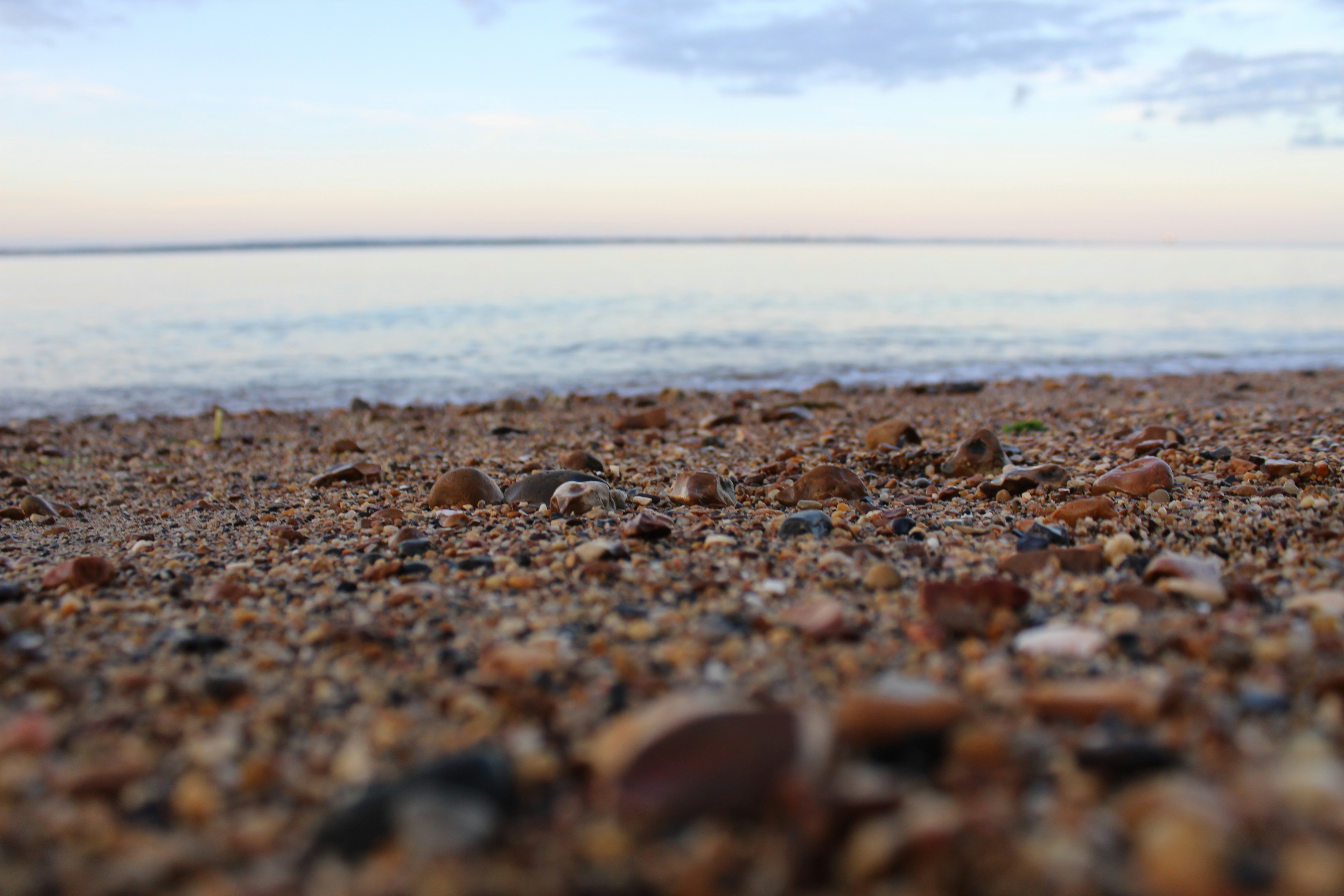 Pebble Beach at Dusk: Calm Shoreline Under a Quiet Sky
