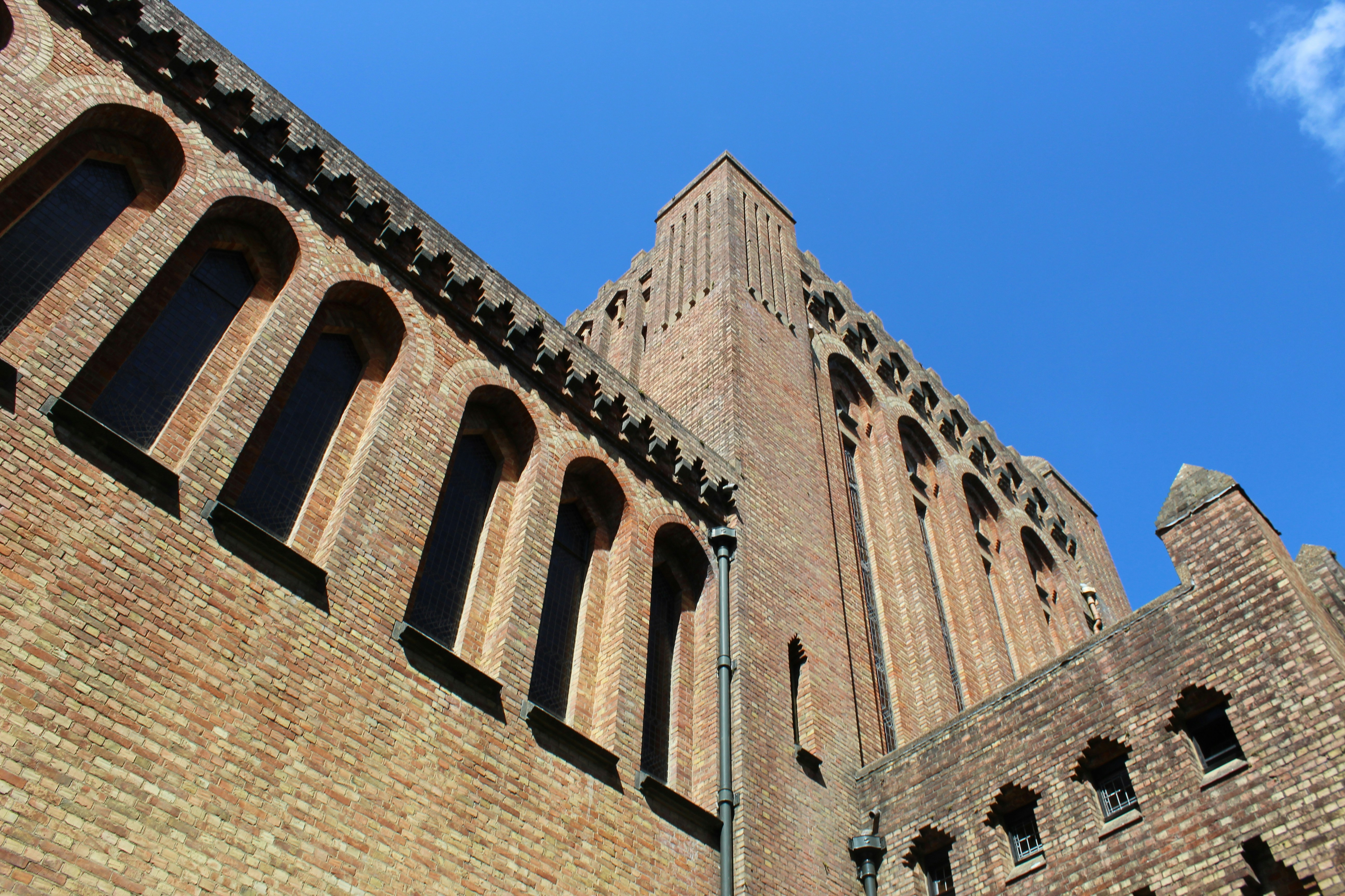 Brick Gothic Rising: A Towering Perspective of Sky and Structure