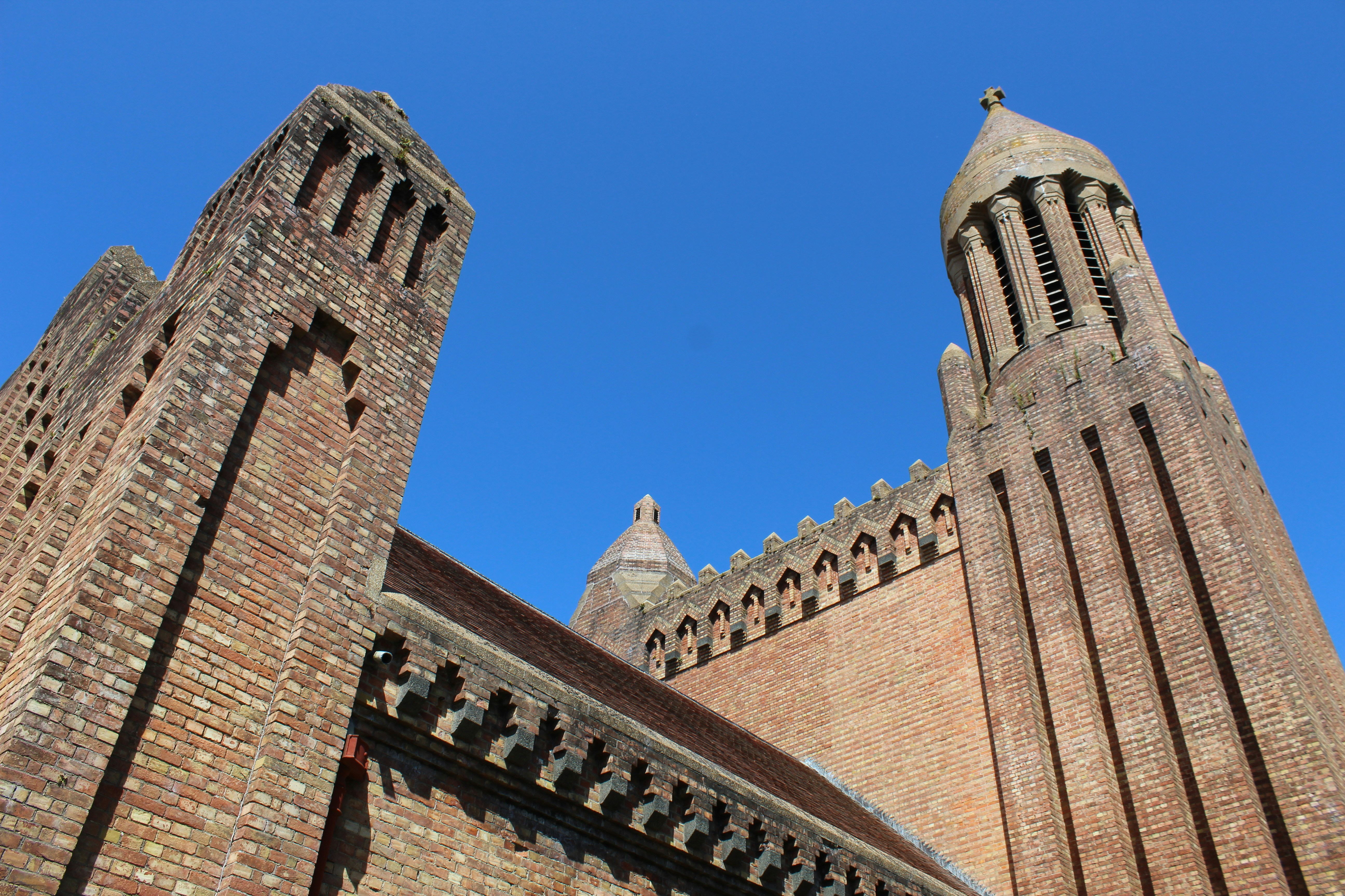 Chiseled Towers Against a Clear Blue: Brick Gothic Facade in Monumental Light