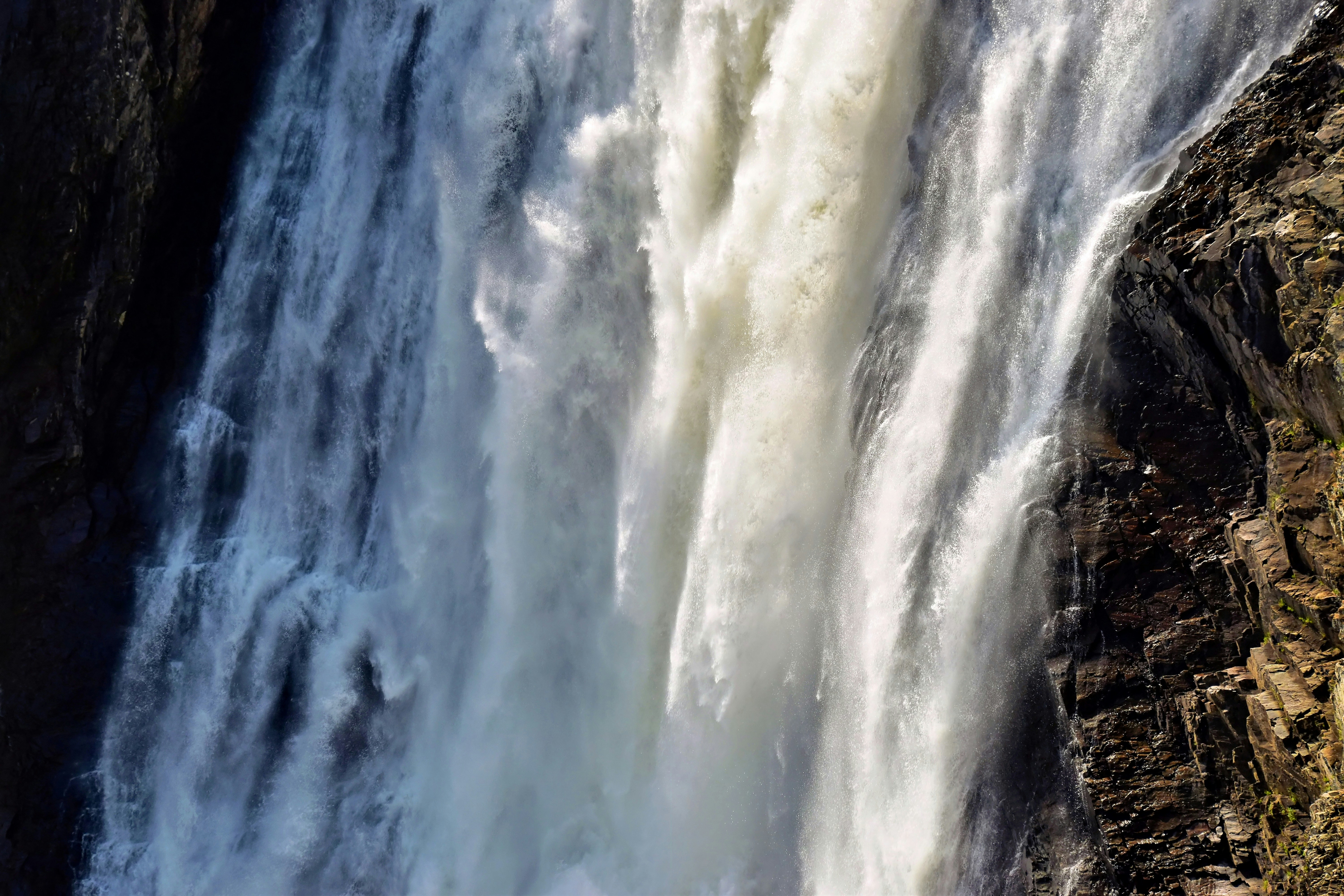 Cascading Veil: A Narrow View of a Majestic Waterfall