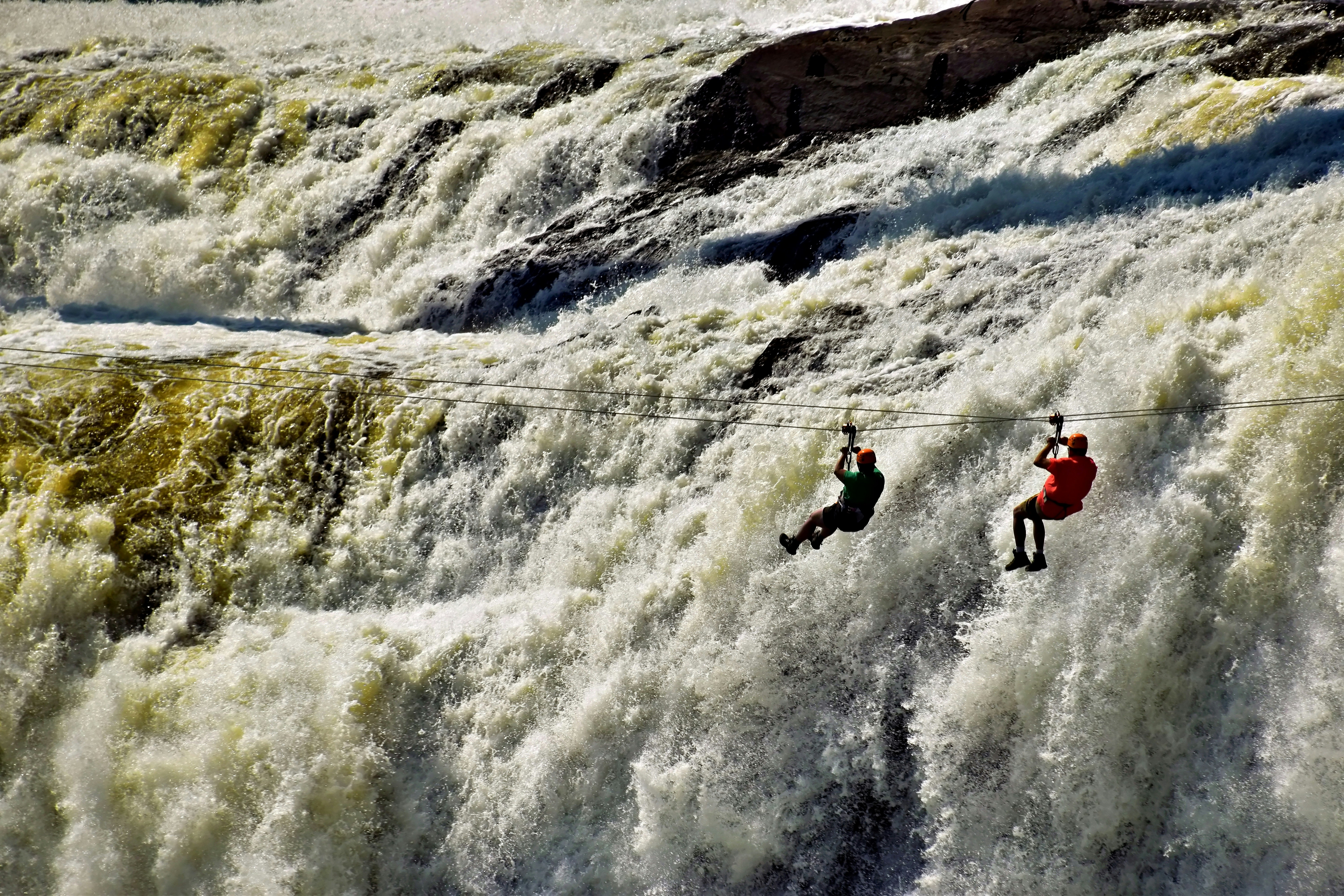 Ridge of Whitewater: Two Kayakers Carving Down a Cascading Falls