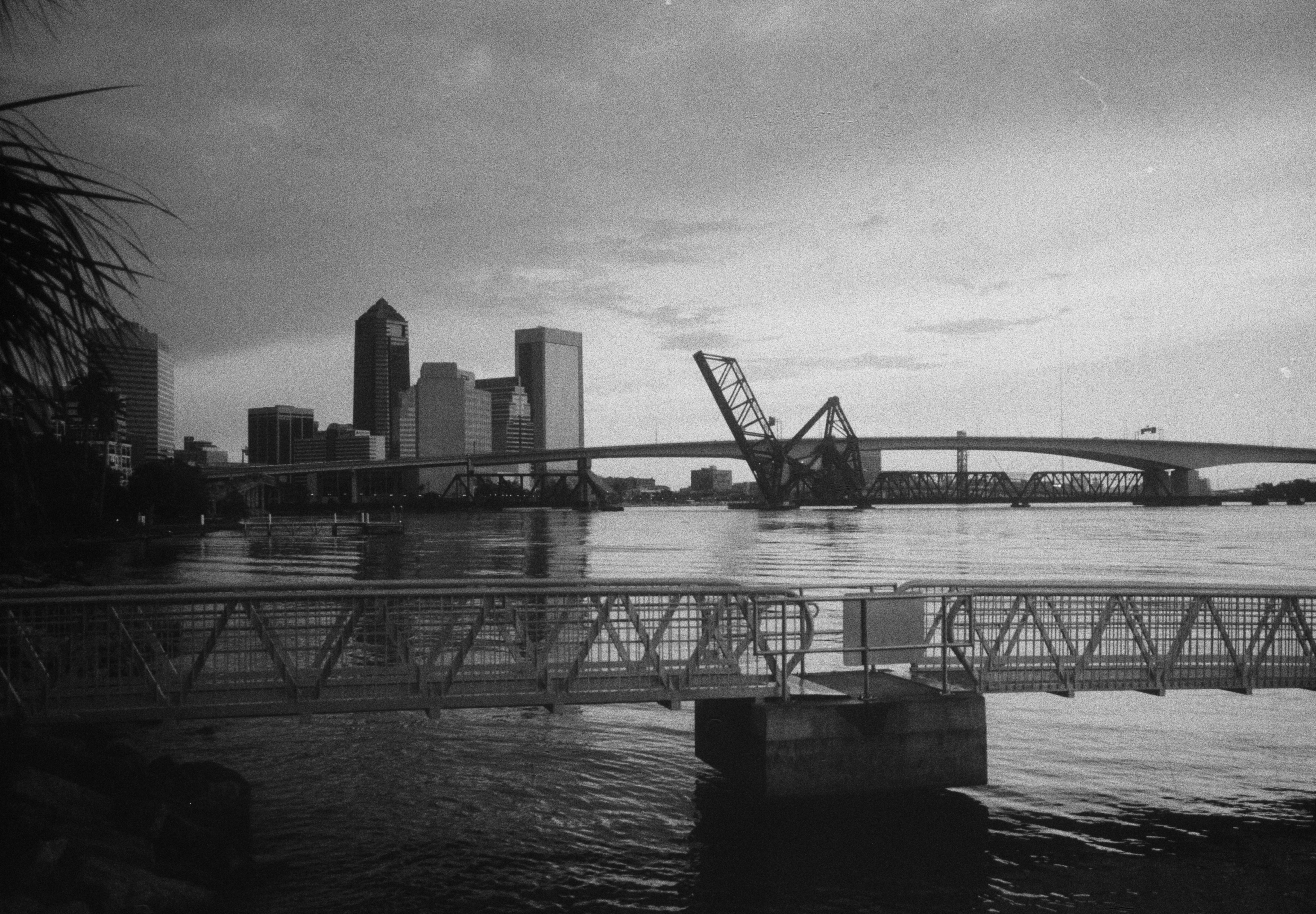 Bridge Reflections over a Quiet Riverfront