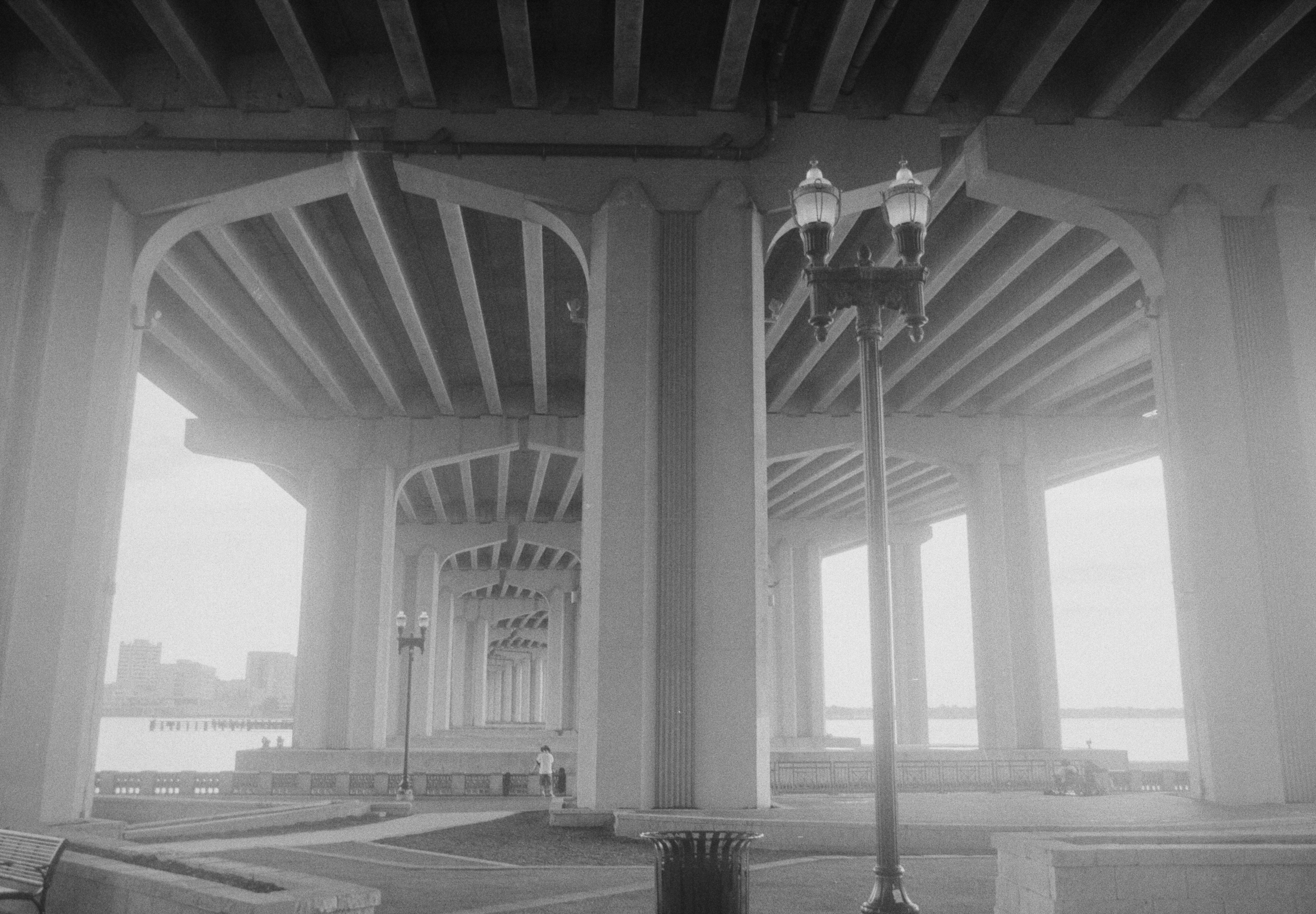 Under the Arched Span: Echoes of a Quiet Waterfront Walkway