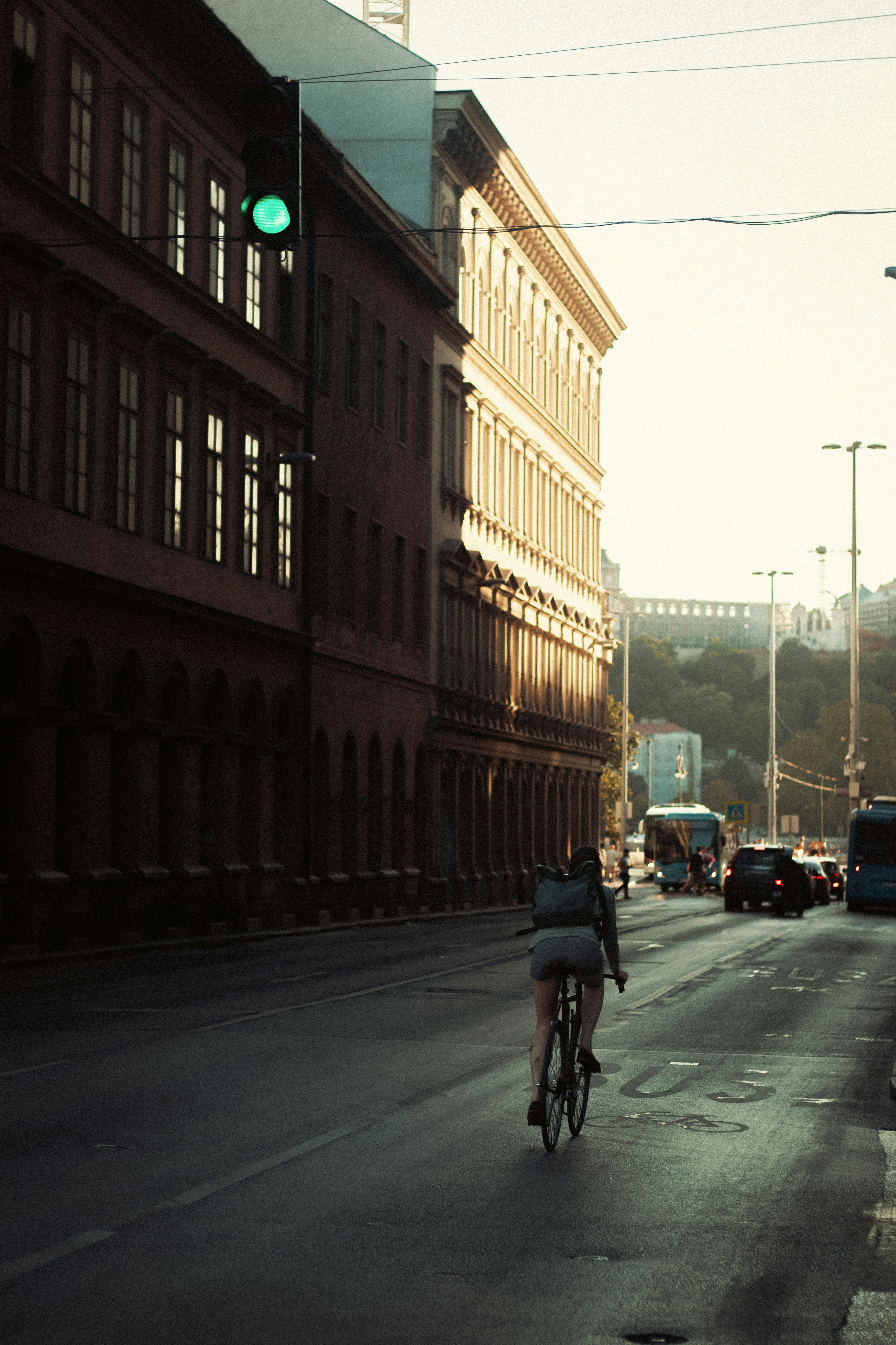 Golden Hour Ride: Street Vista with Cyclist Surging Toward the Light