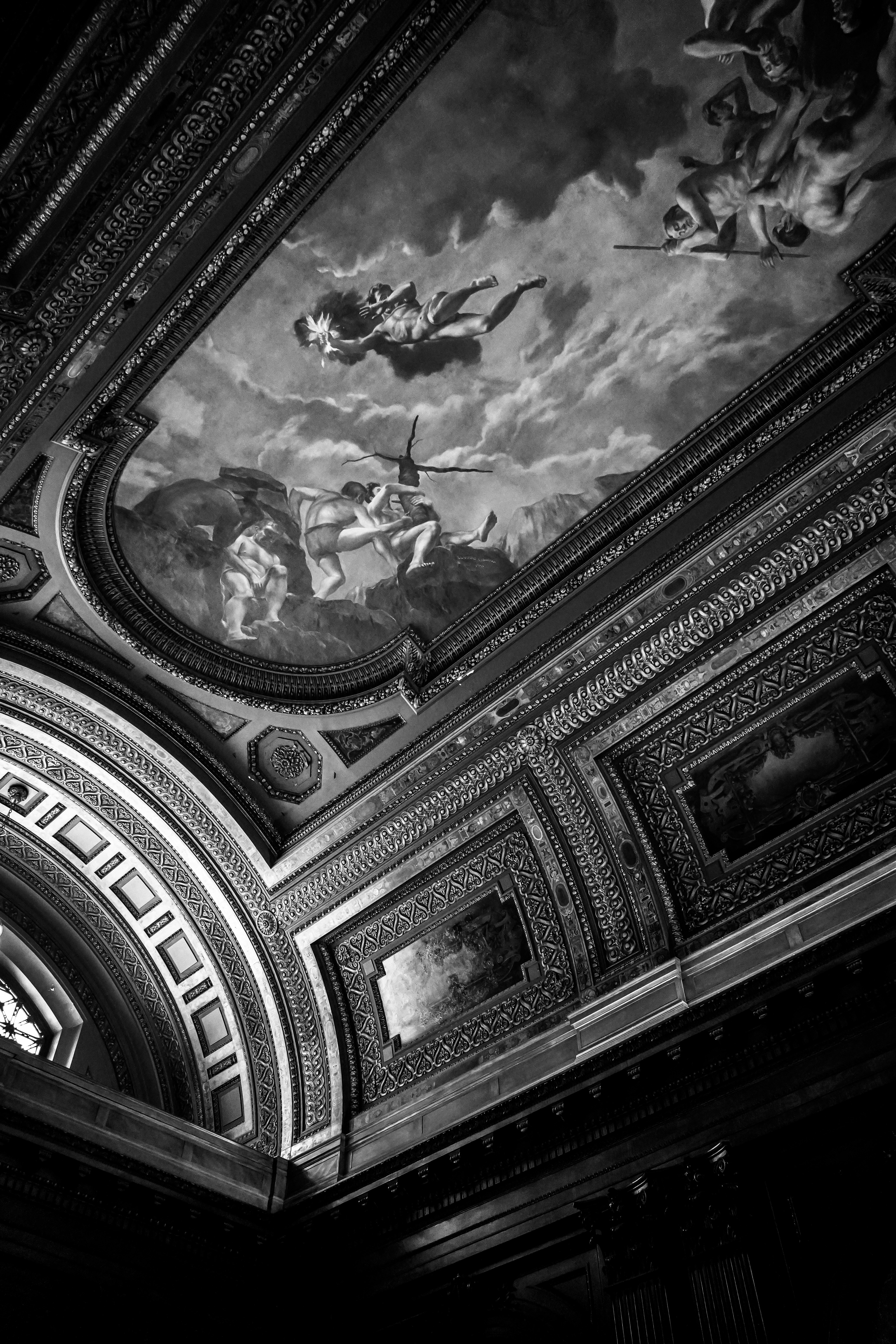 Ornate Ceiling Symphony: Baroque Panels Stretch Across Darkened Architecture
