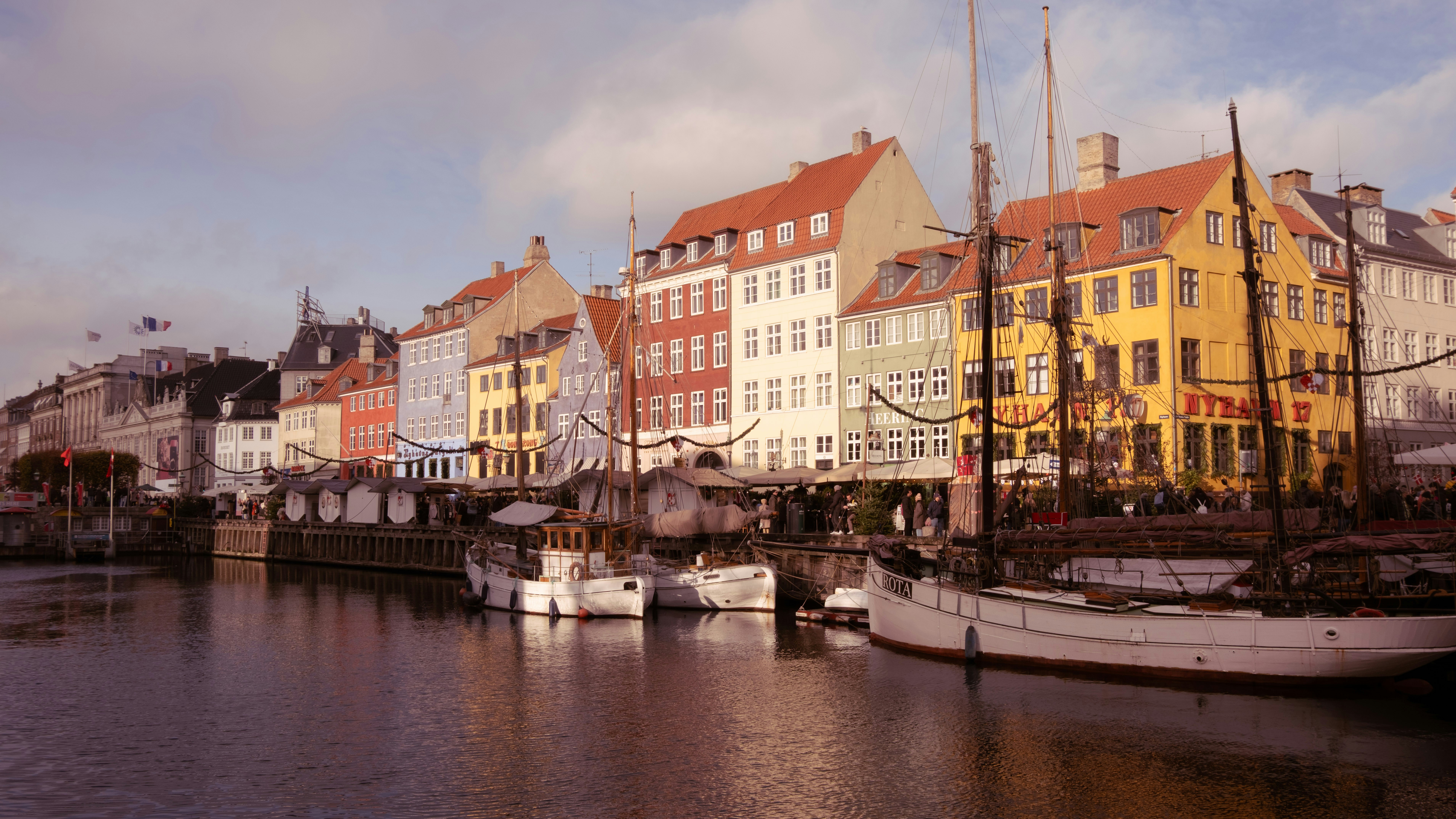 Colorful Row of Nordic Waterfront Dwellings Framed by Sailboats