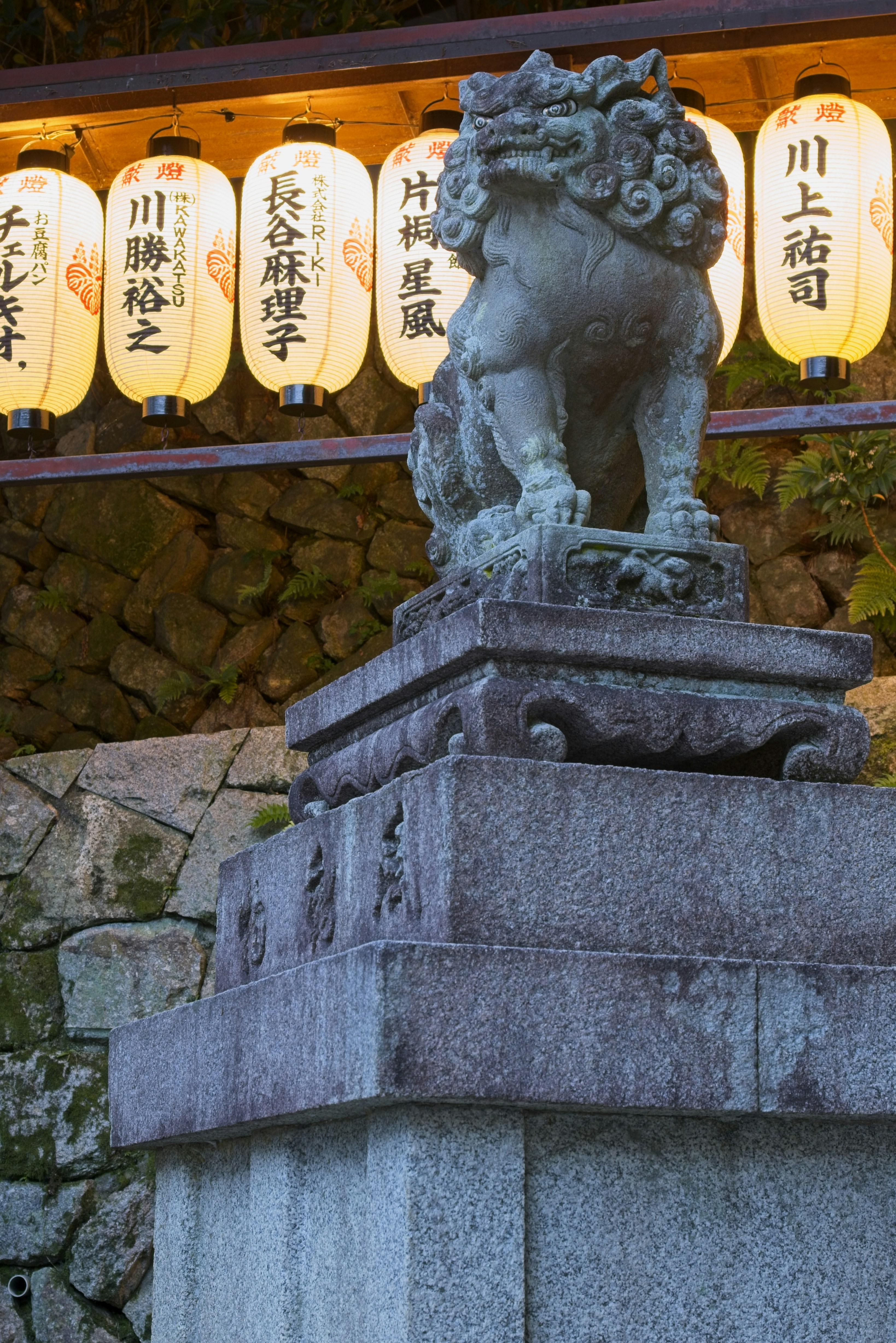 Guardian in Stone Under Lantern Light