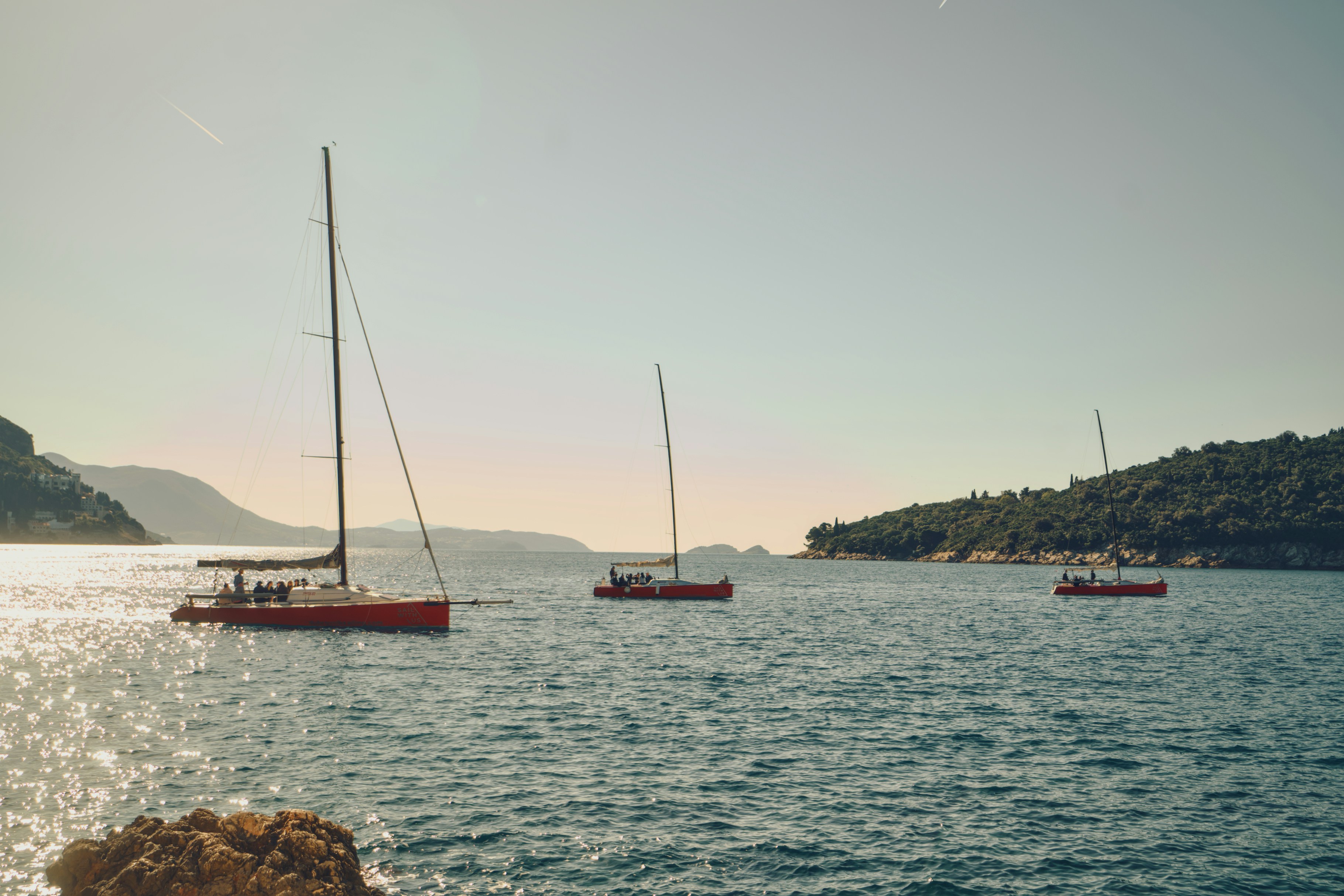 Sailboats at Dusk: Tranquil Bay Under Gentle Light