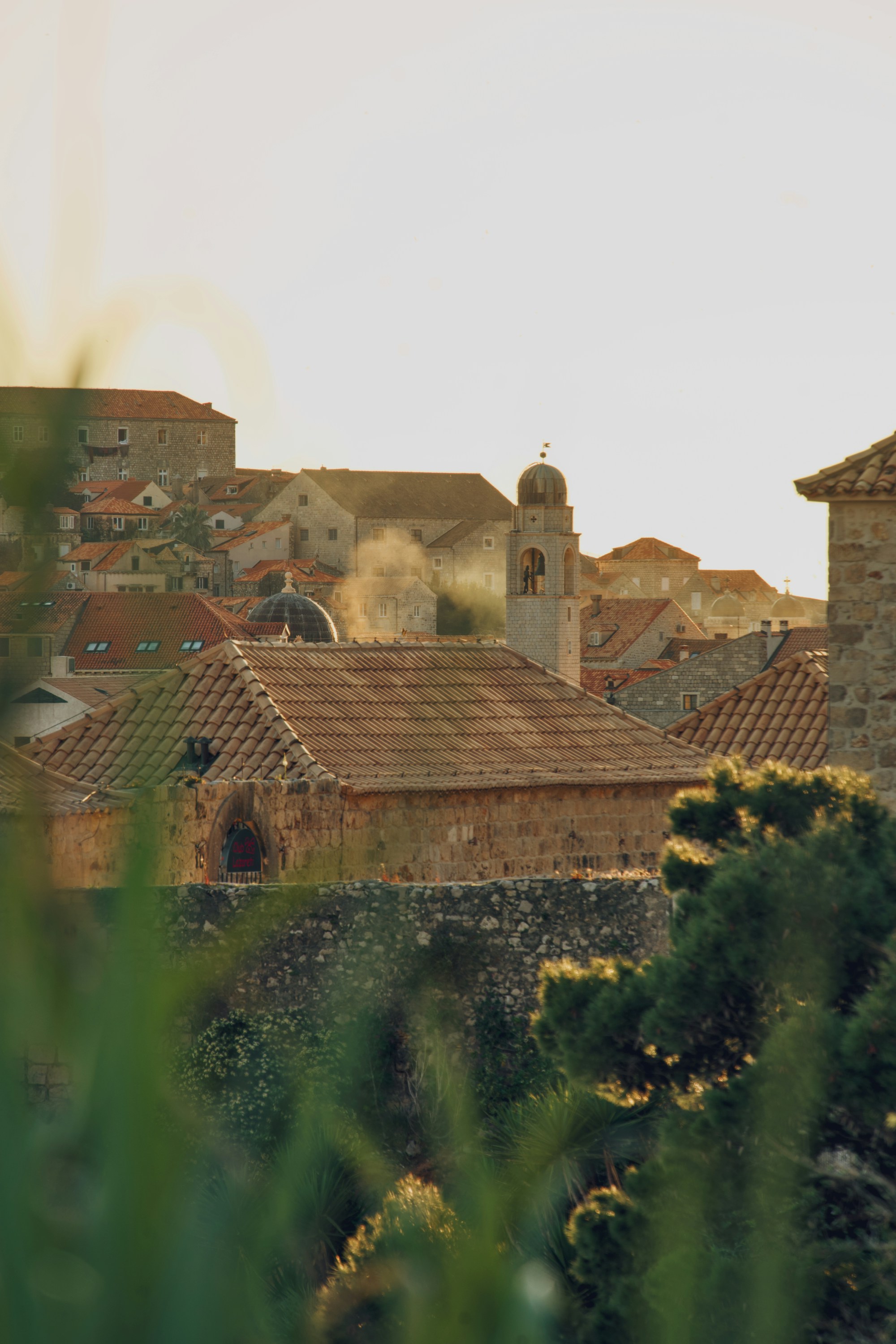 Sunlit Hilltown Rooftops and Clocktower in Calm Evening Tone