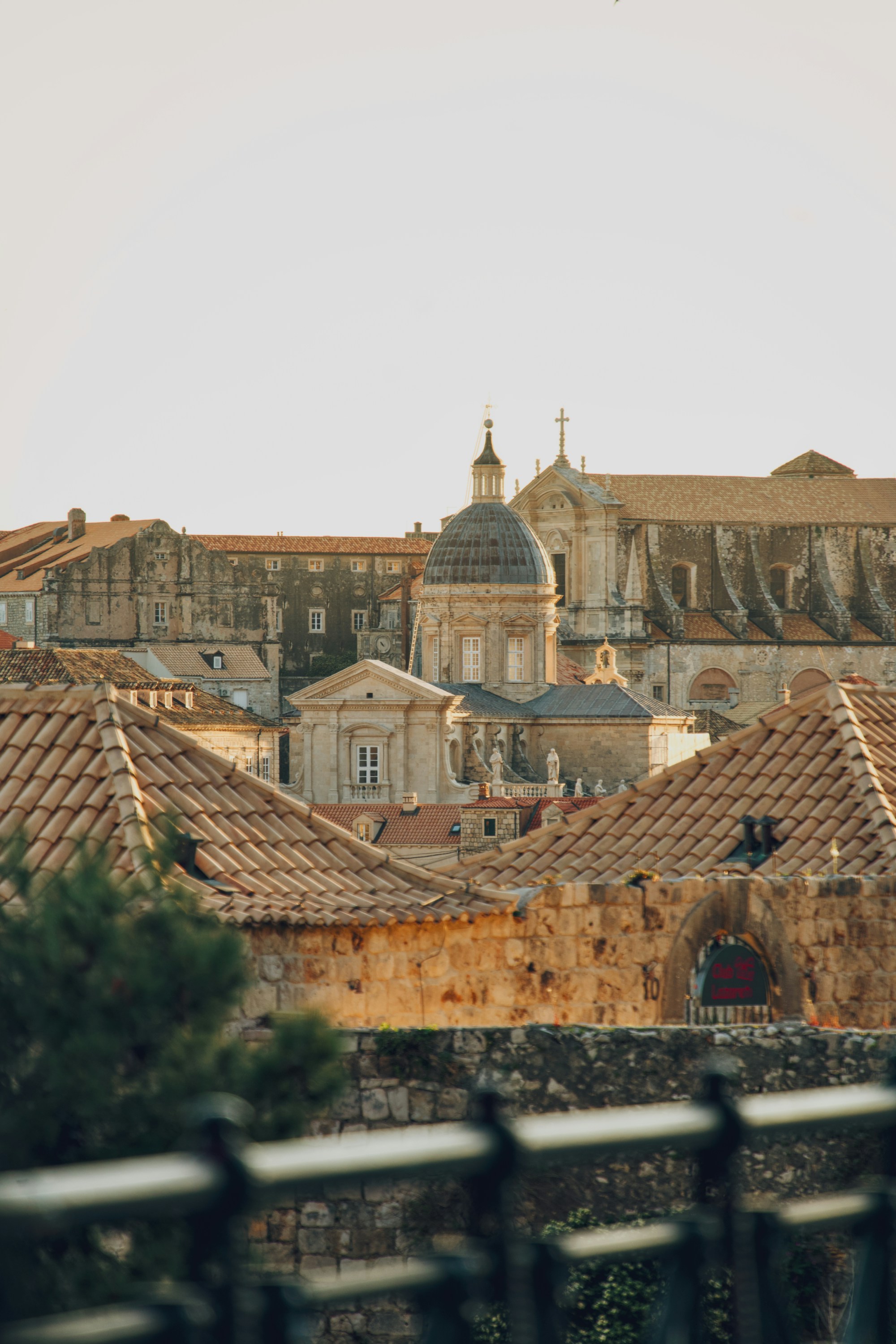 Sunlit Old Town: Rooftops and Dome against a Clear Sky