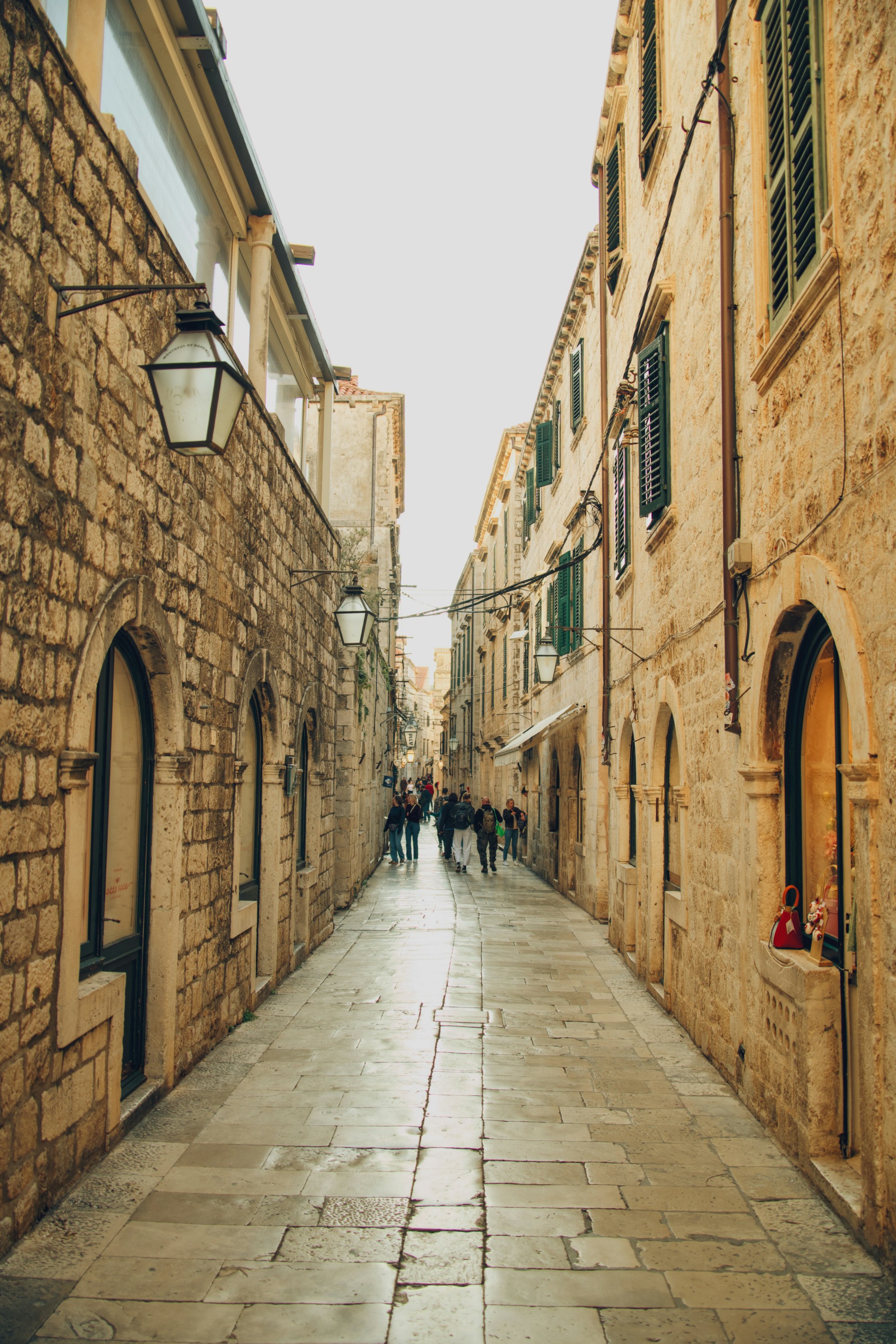 A Quiet Medieval Lane: Stone Facades and Distant Gathers