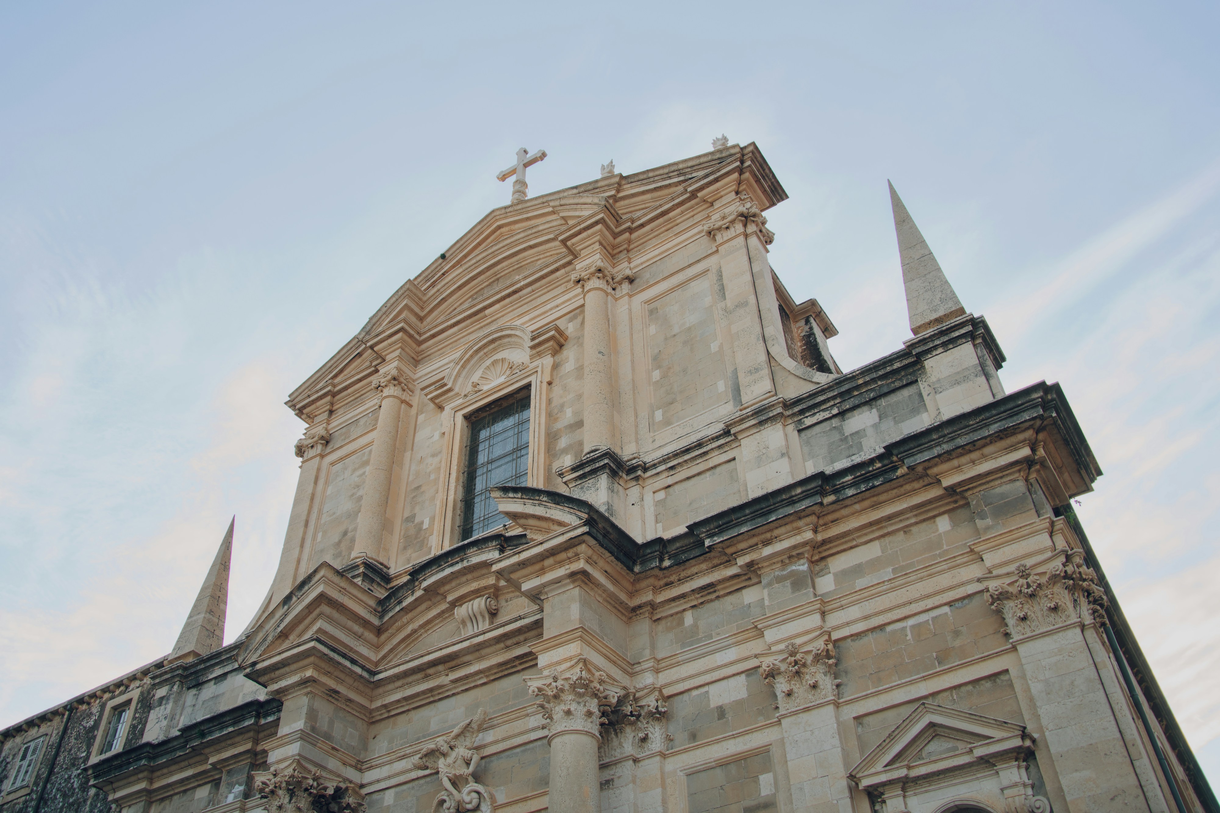 Stone Facade Rising: A Medieval Church Under a Soft Dusk Sky