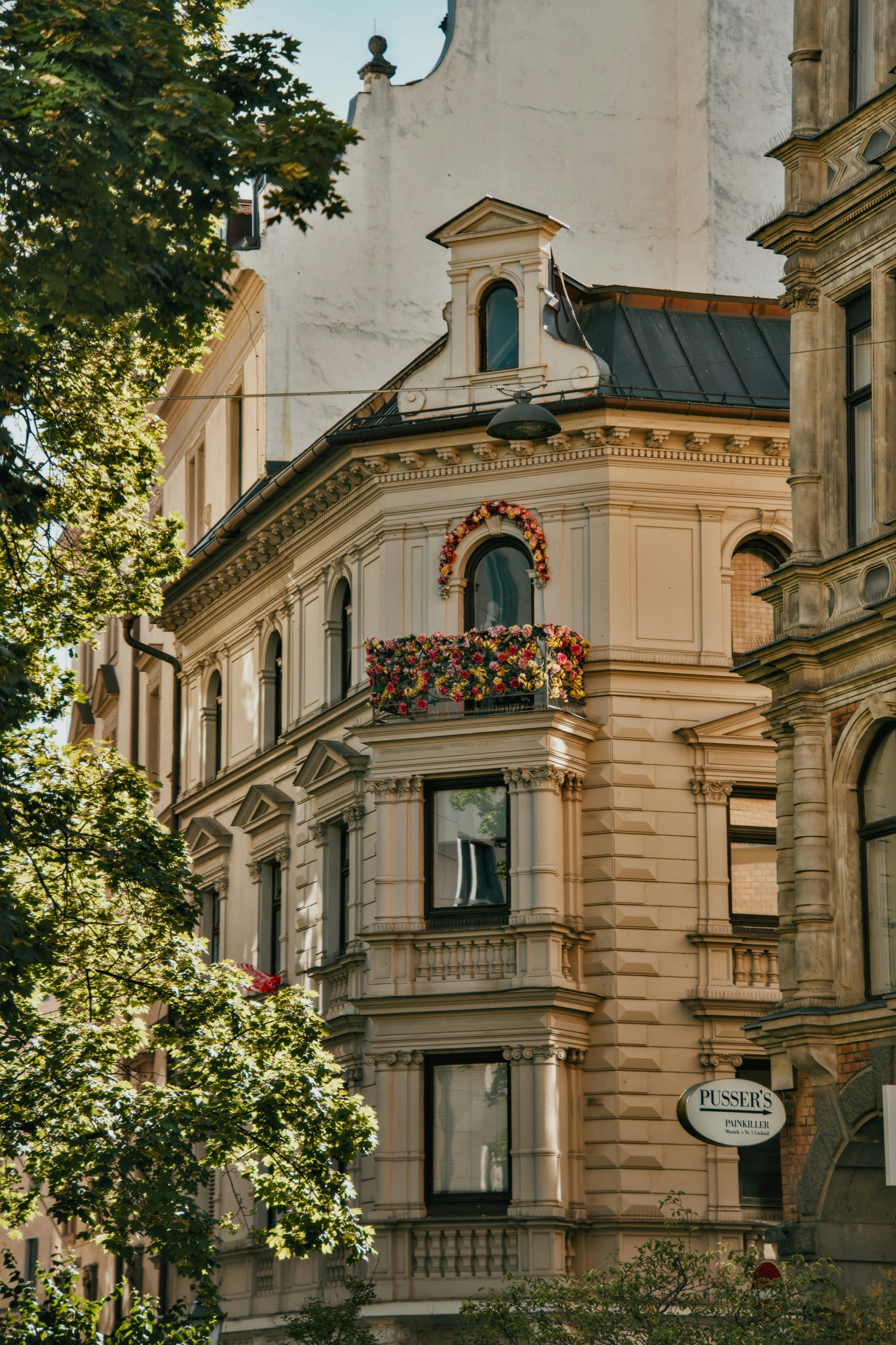 Ornate Cornerstone: A Pale Facade with Floral Balcony