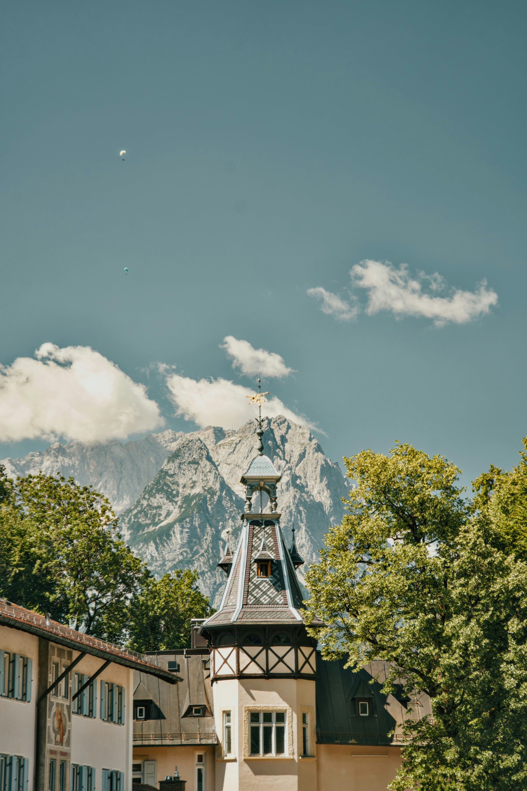 Chalet Peak: Alpine Clocktower Beneath Snowy Peaks
