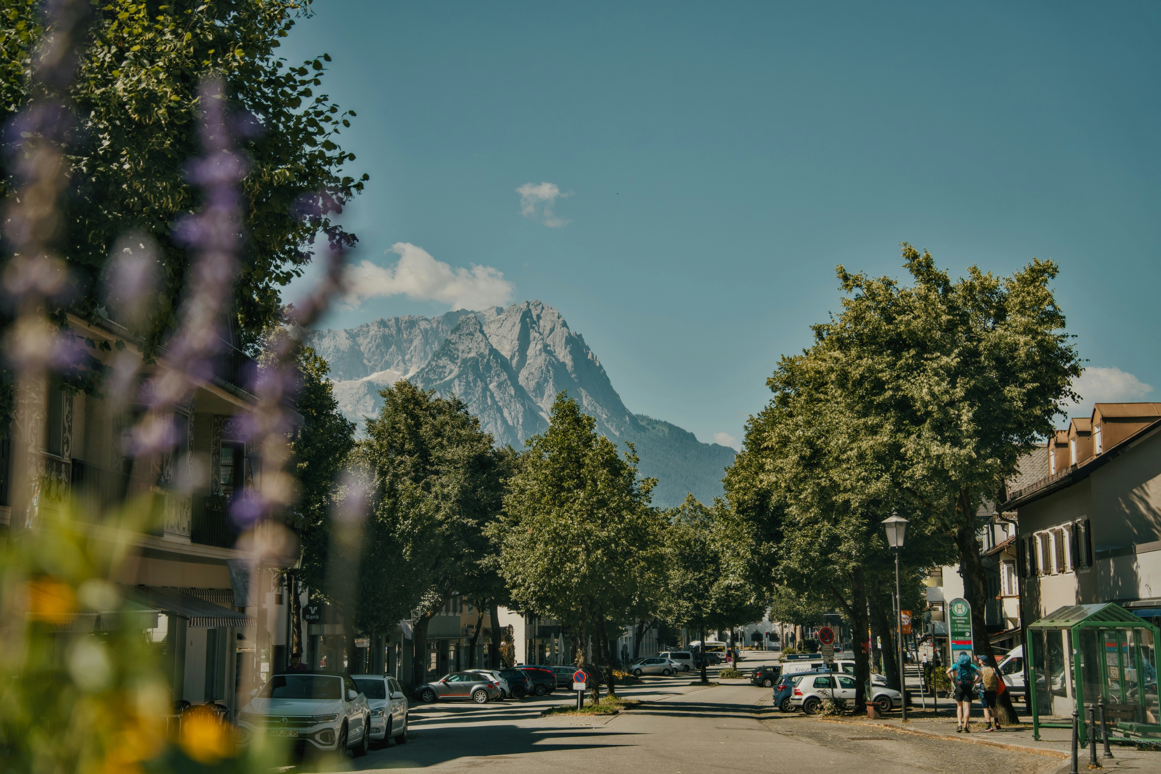 Sunlit Main Street Framed by Alpine Backdrop