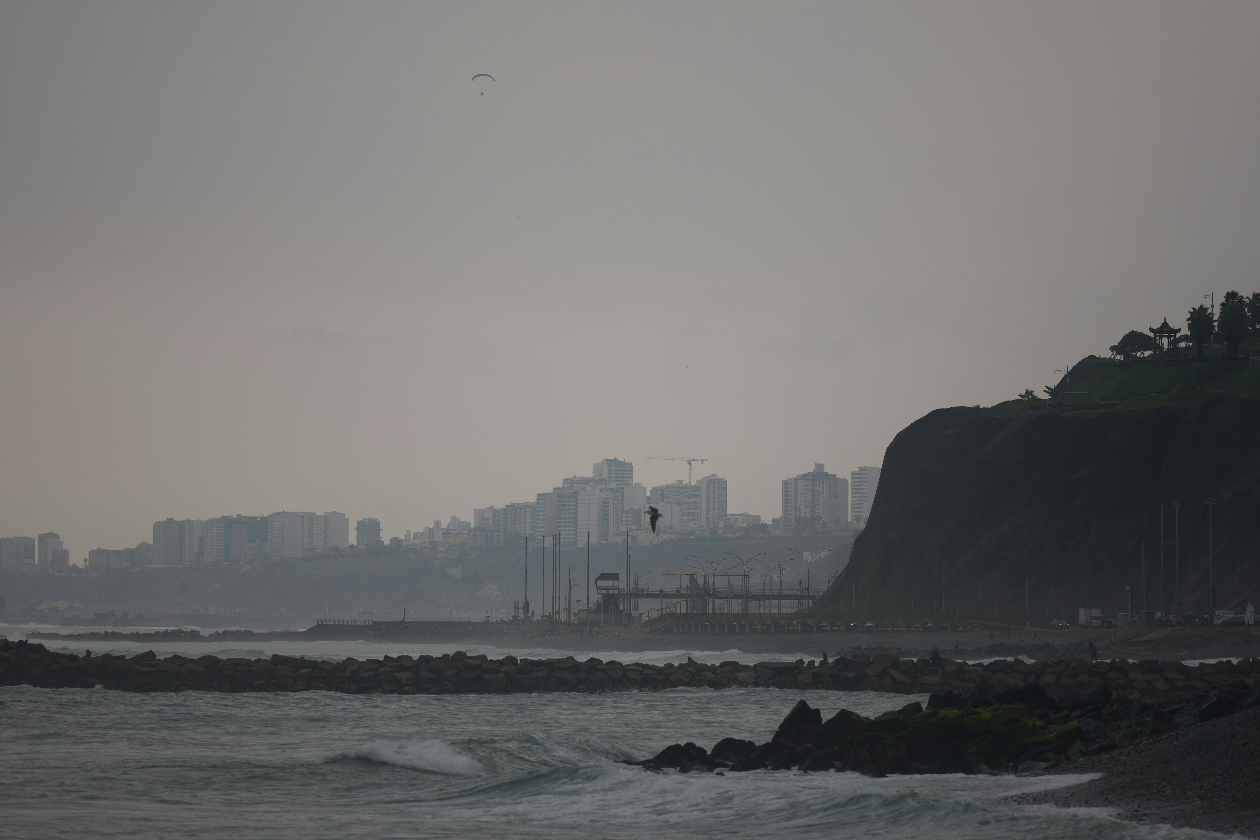Coastal Cliff Overlook into a Misty City Horizon