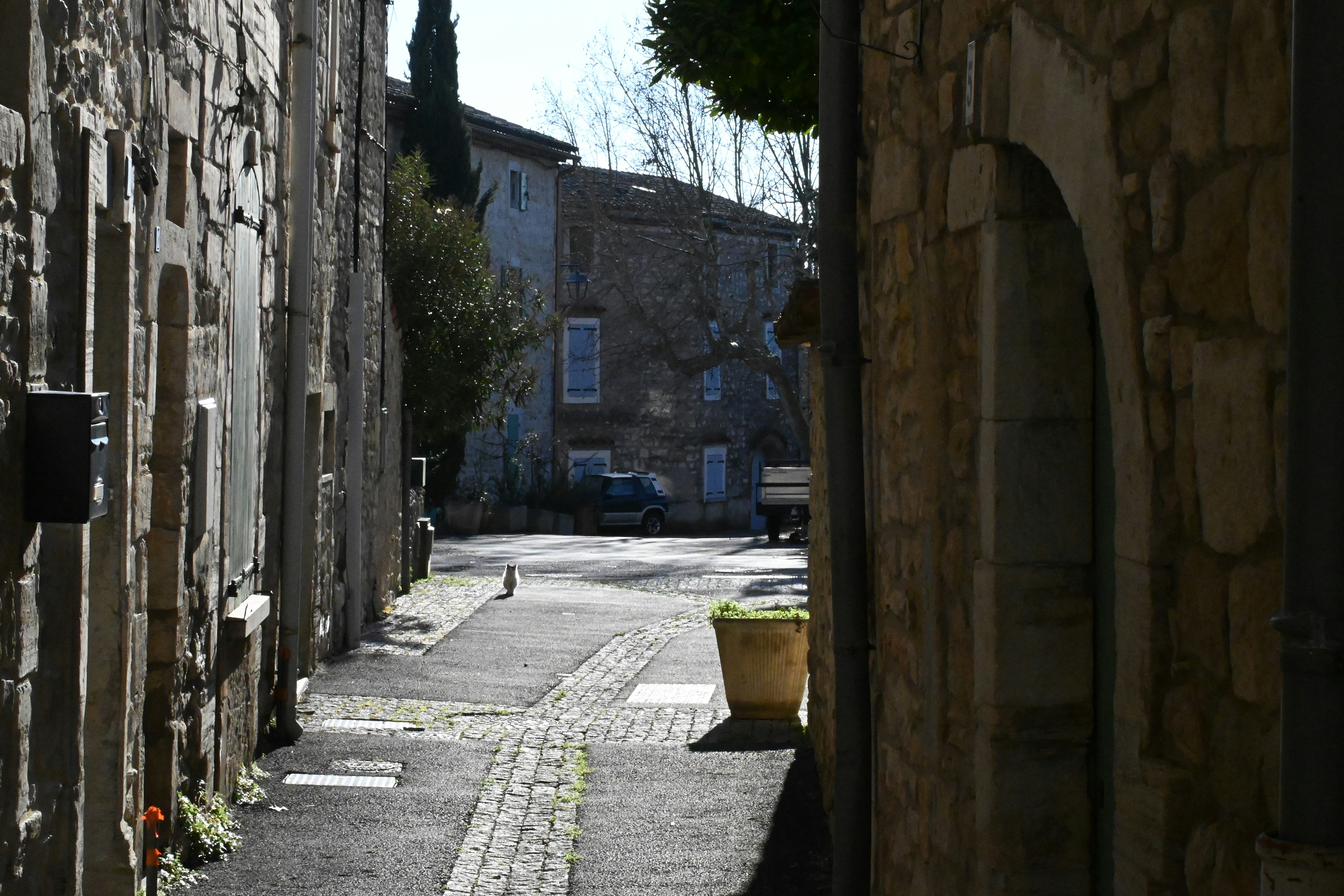 Stone-Walled Alley Leading to a Quiet Street