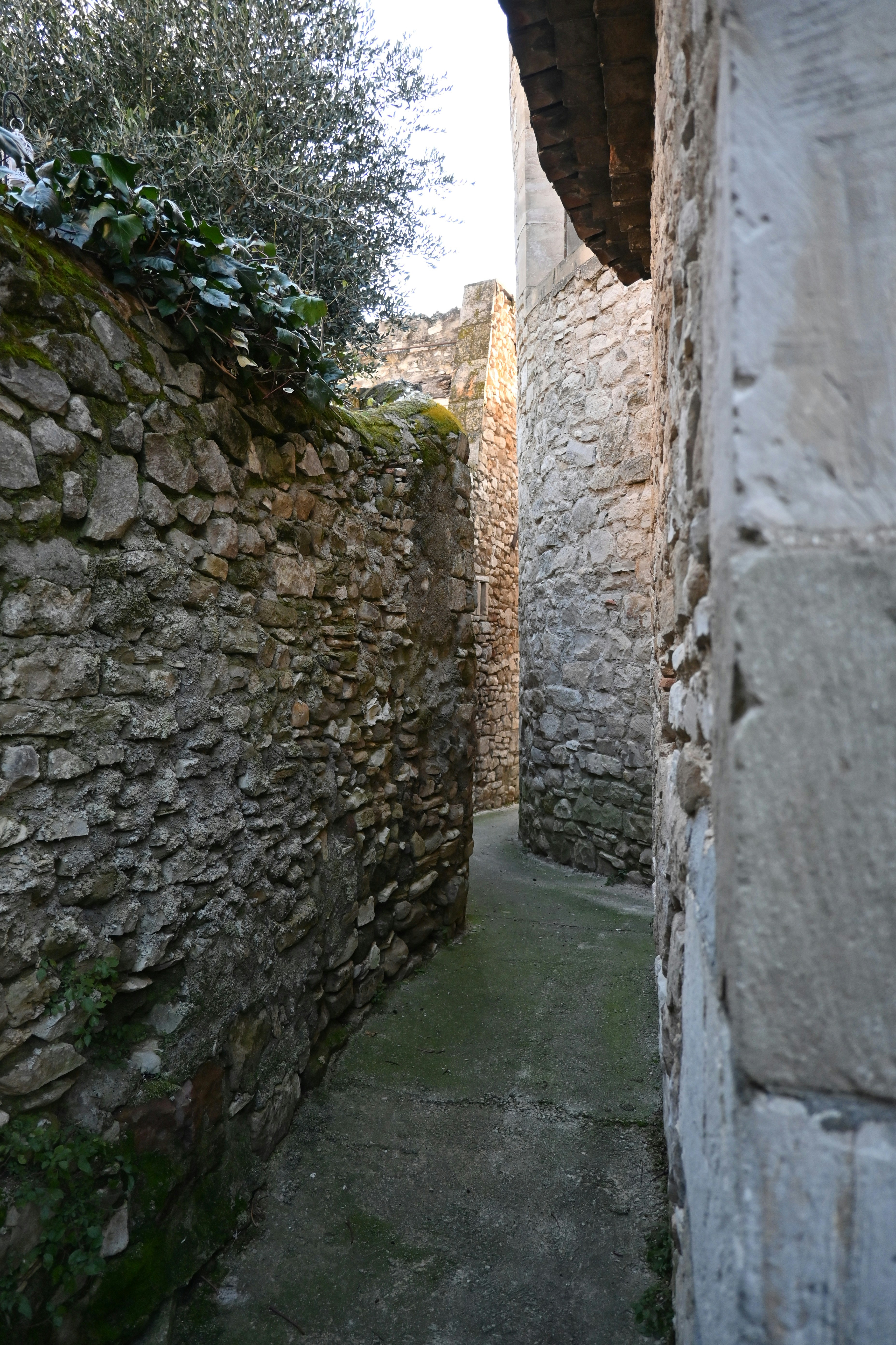 Cobbled Corridor Between Ancient Stone Walls