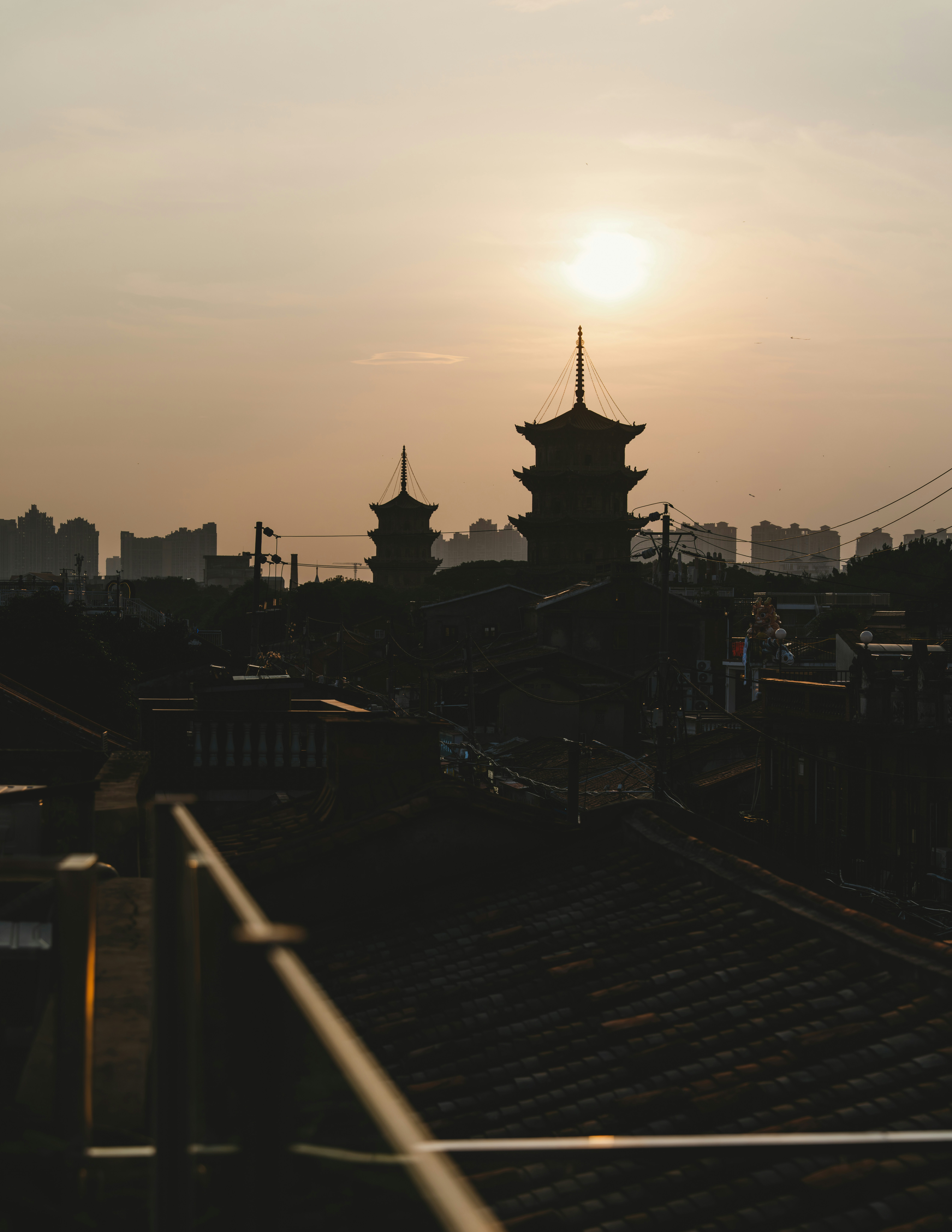 Sunlit Silhouette Over Temple Rooftops at Dusk