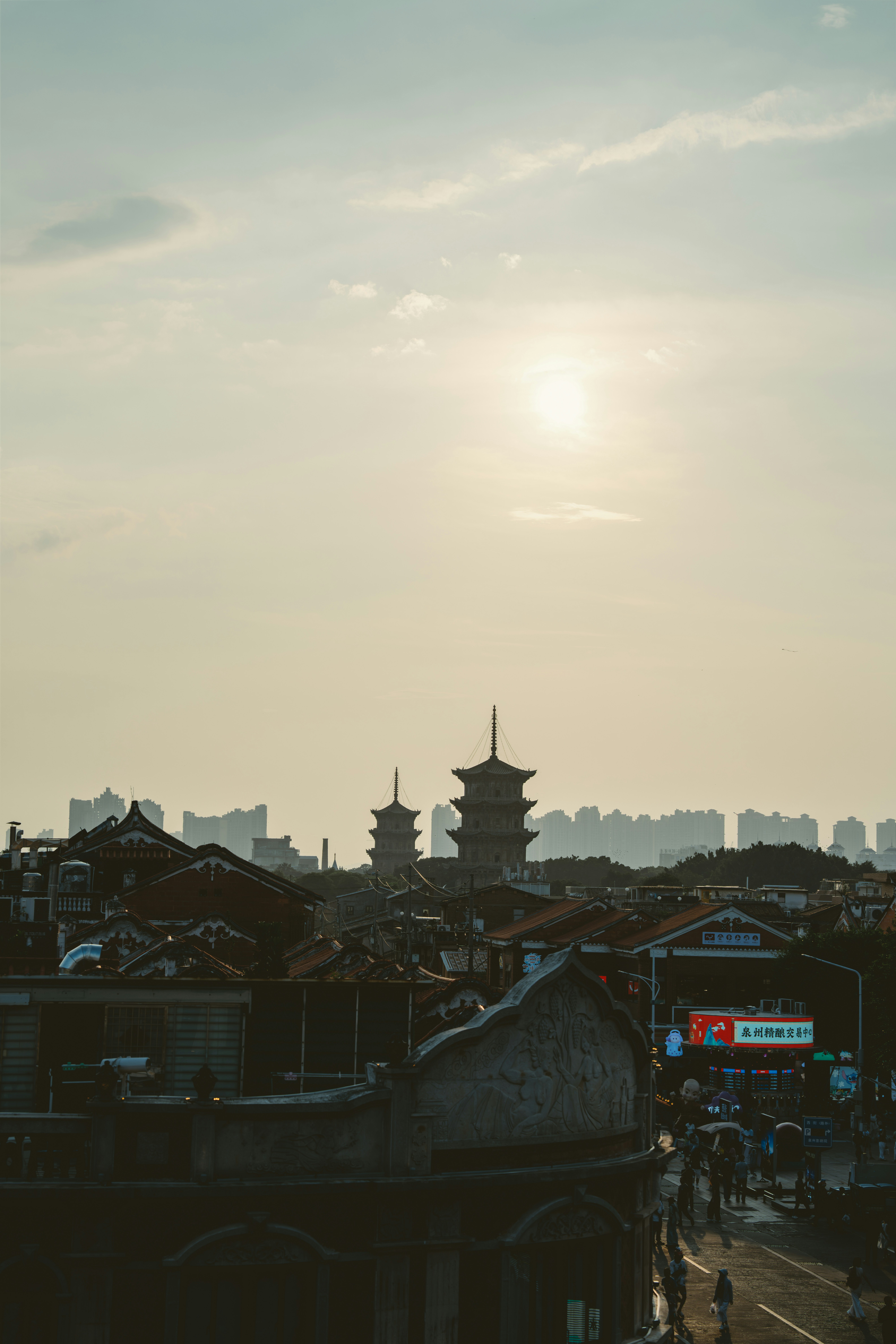 Sunlit skyline over a traditional Chinese pagoda row at dusk