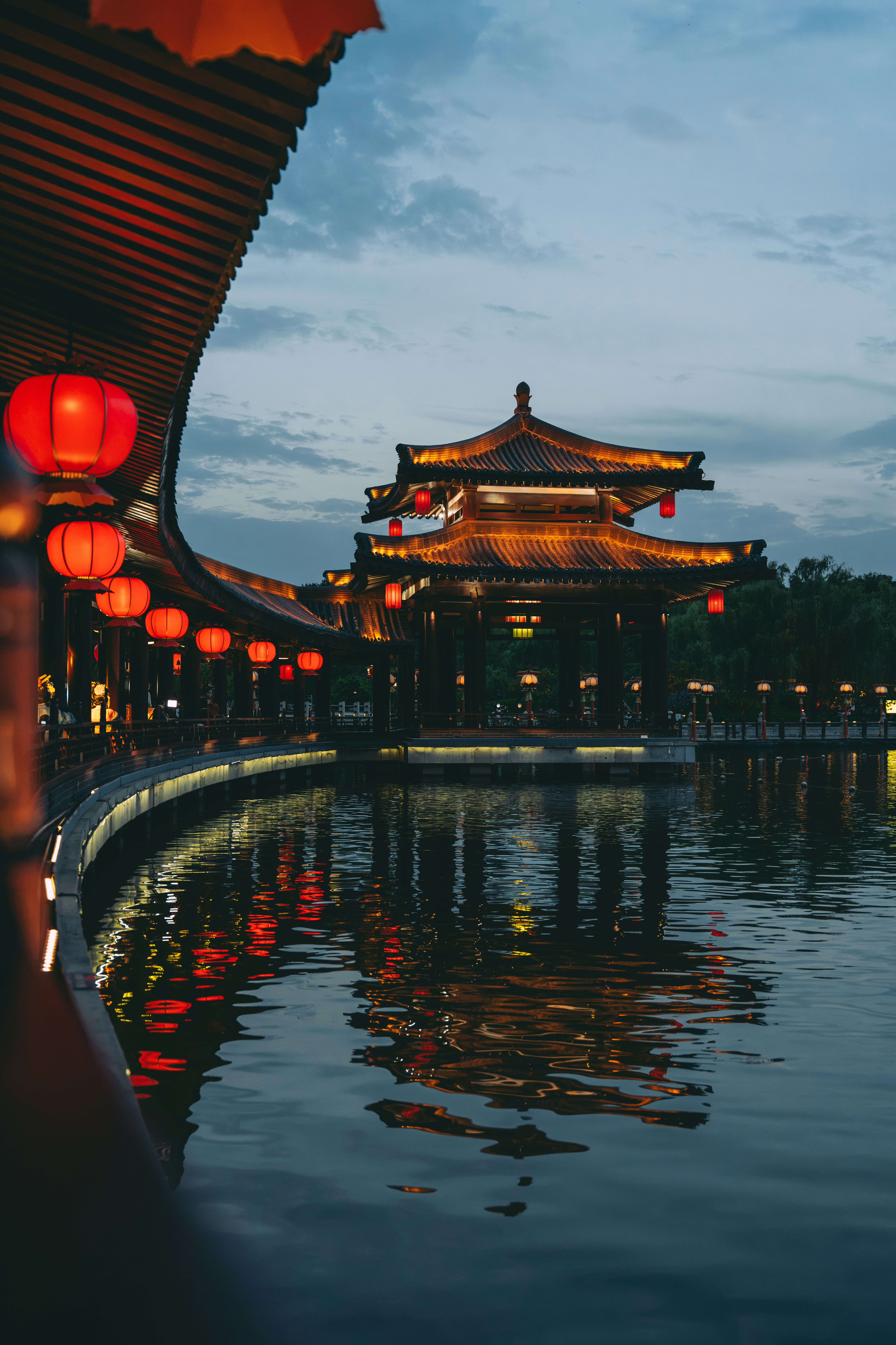 Red Lantern Reflections Over Calm Water at a Traditional Pavilion