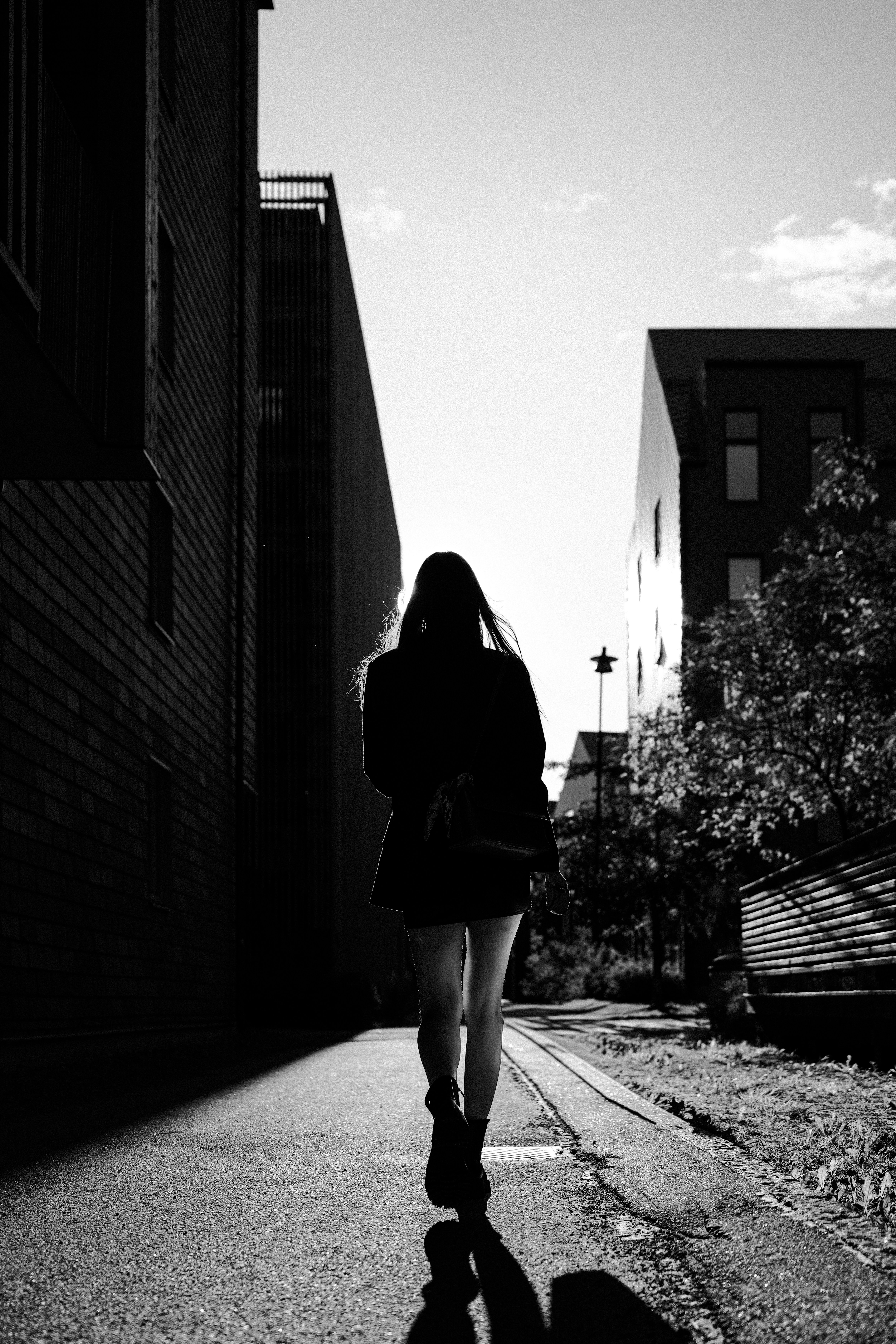 Midday Shadow Walk: A Silhouette in the Narrow Street