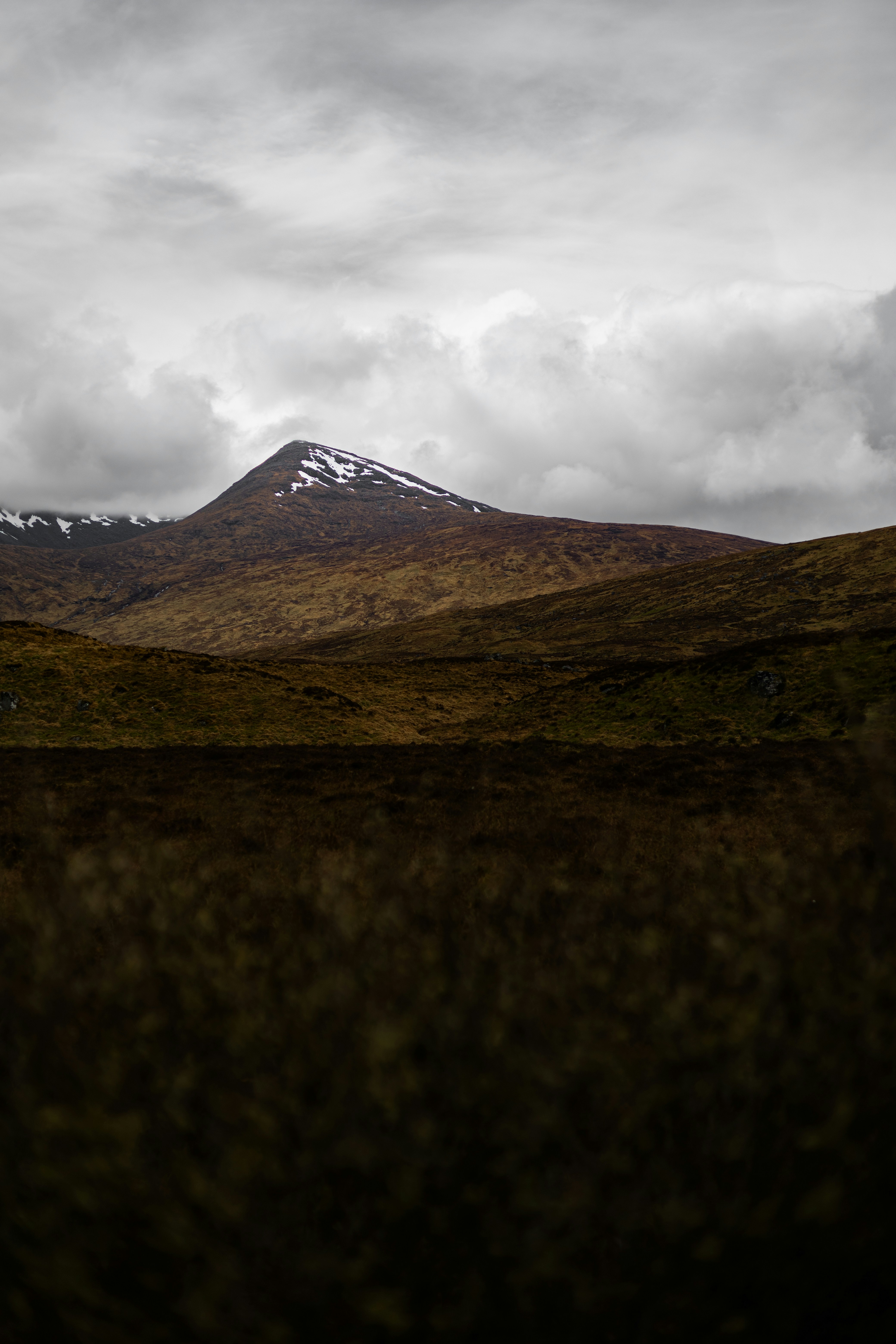 Snow-tipped ridge under brooding skies