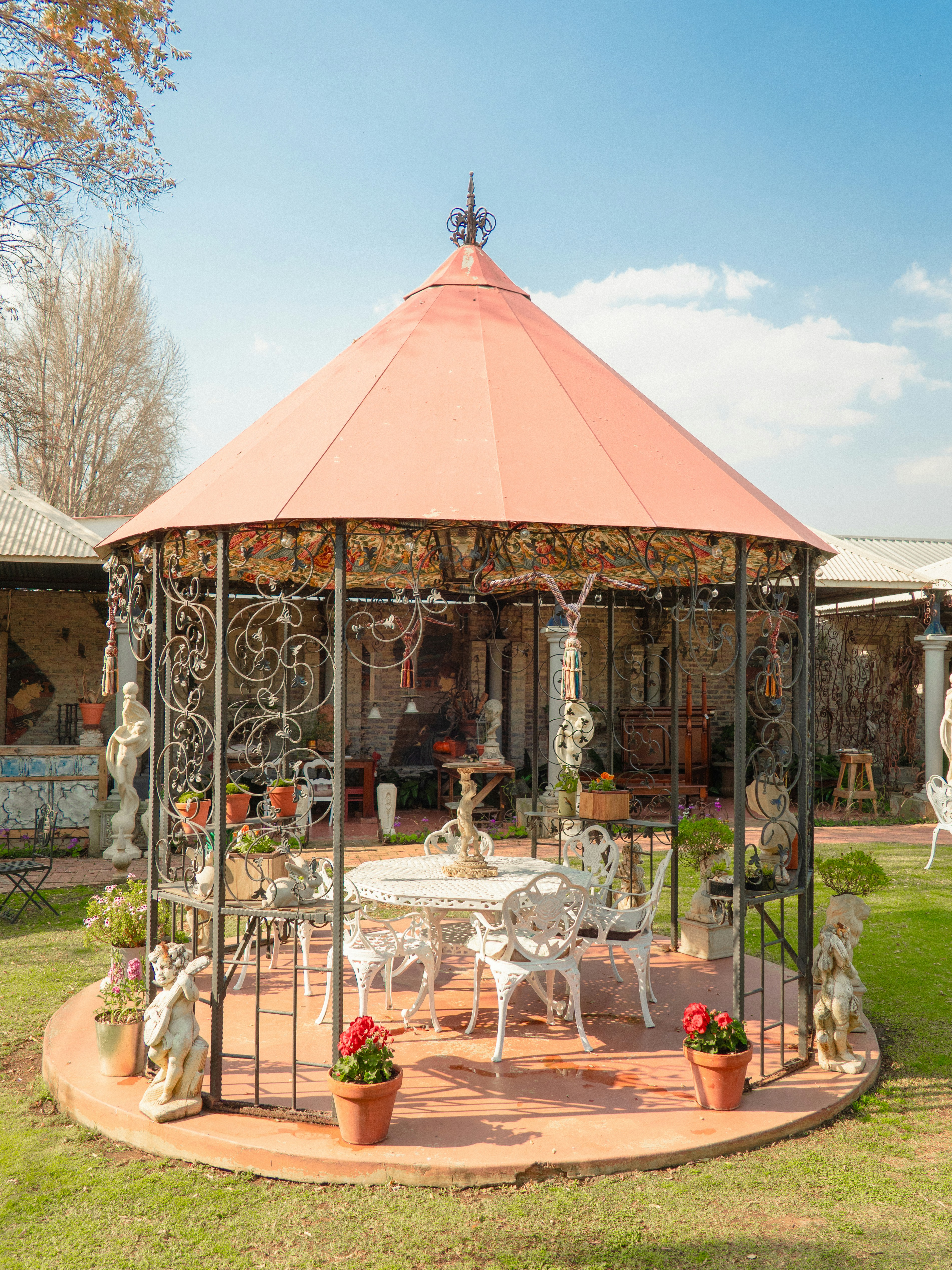 Ornate Gazebo Retreat: A Copper-Topped Haven of Statues and Shadows