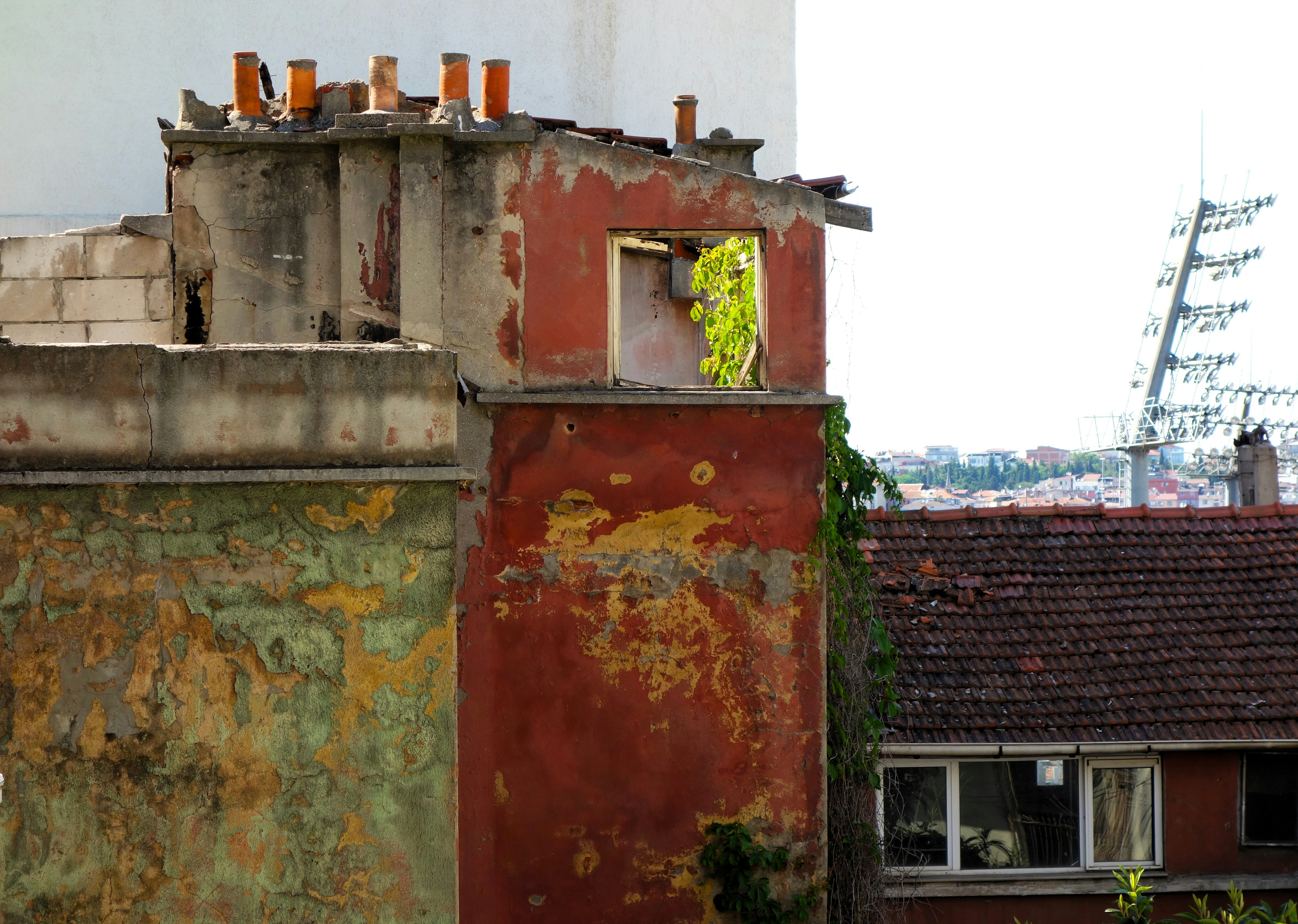 Rusted Chimneyline: Quiet Decay Against a Distant Skyline