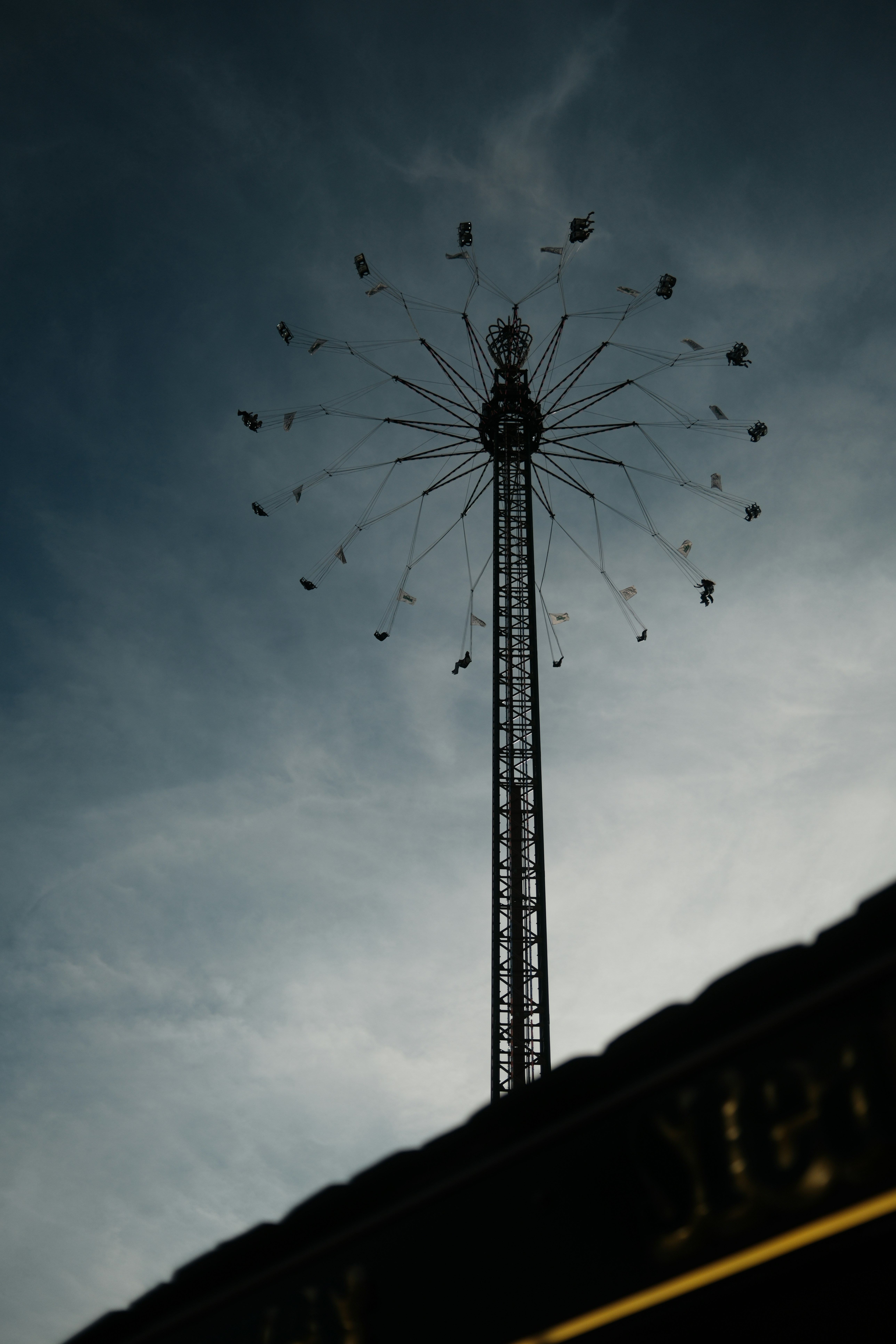 Skyward Swing: The Ferris Wheel Tower Reaches the Dusk