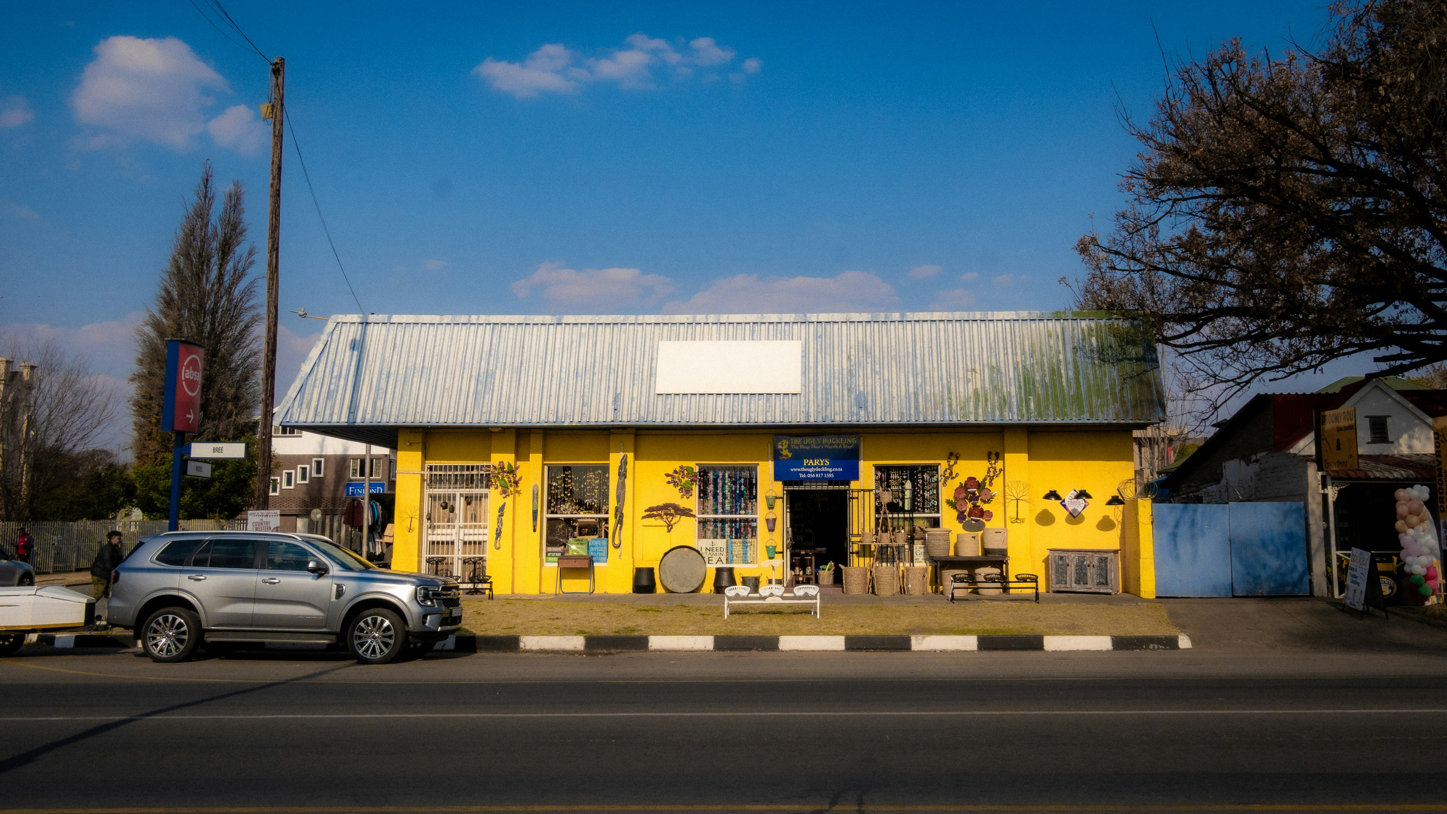 Sunlit Yellow Market Facade on a Quiet Street