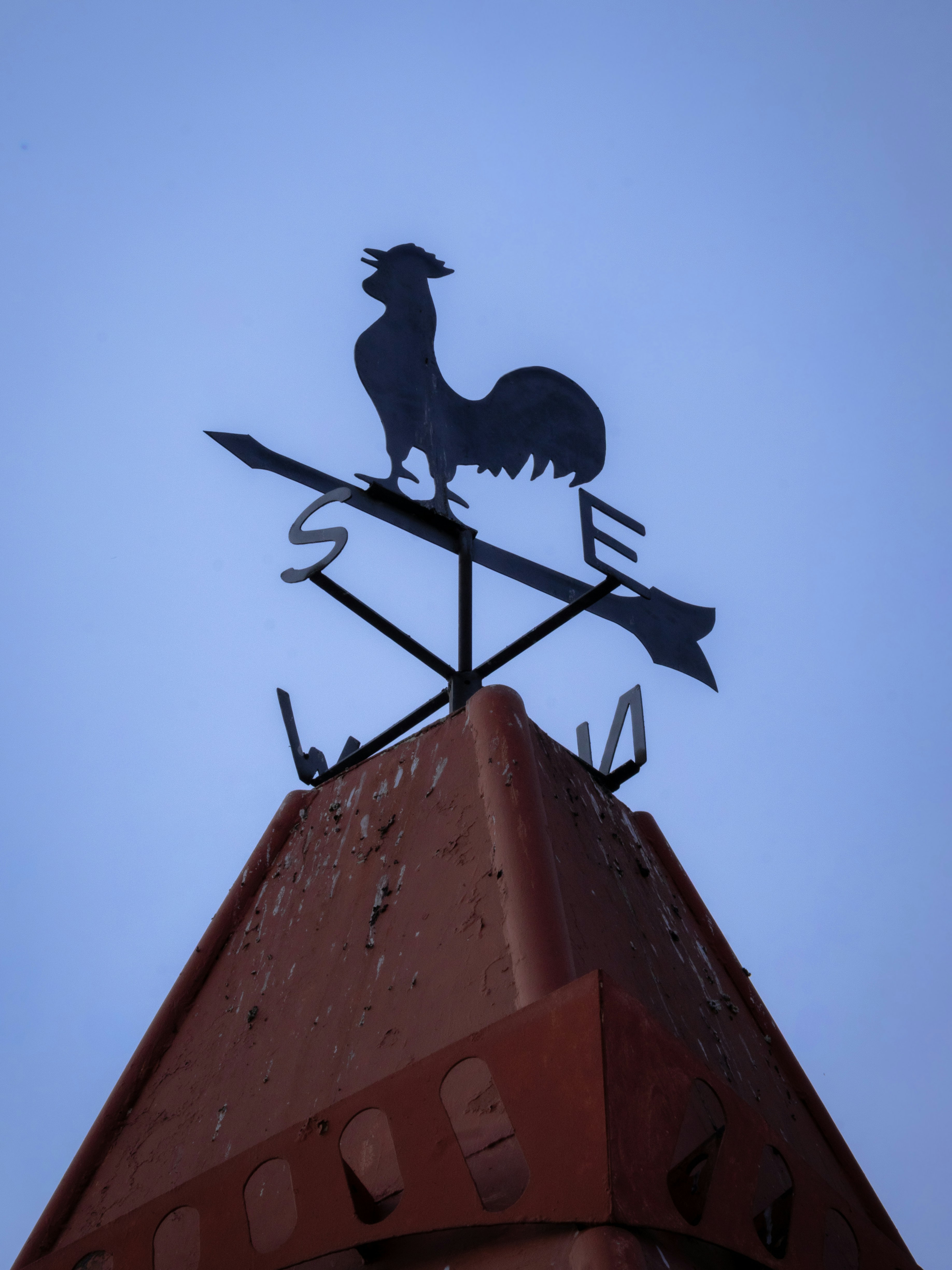 Rooster Weather Vane Crowned by a Weathered Peak