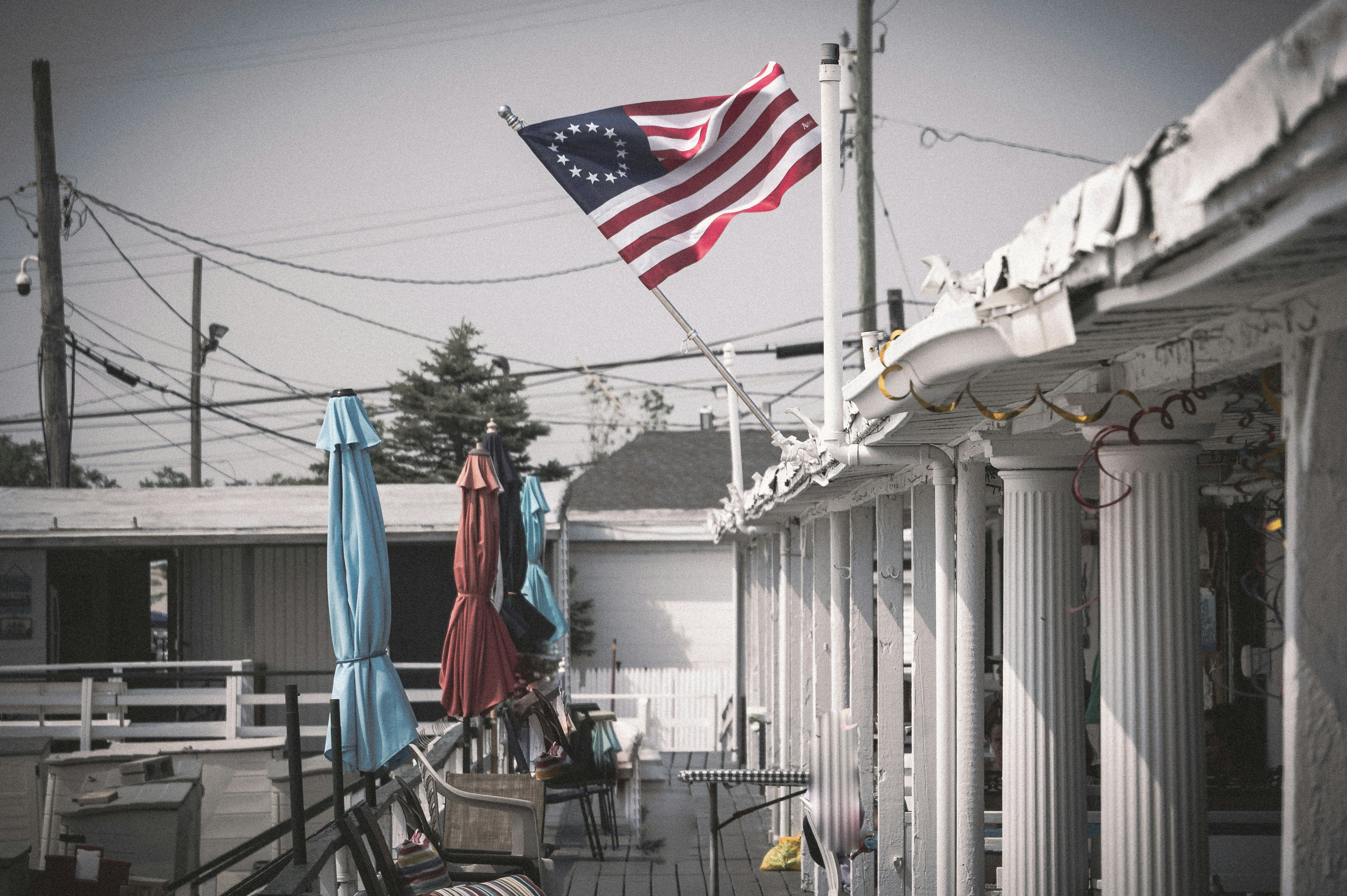 Patio Breezes and a Flag: Quiet American Dusk at the Seaside Courtyard