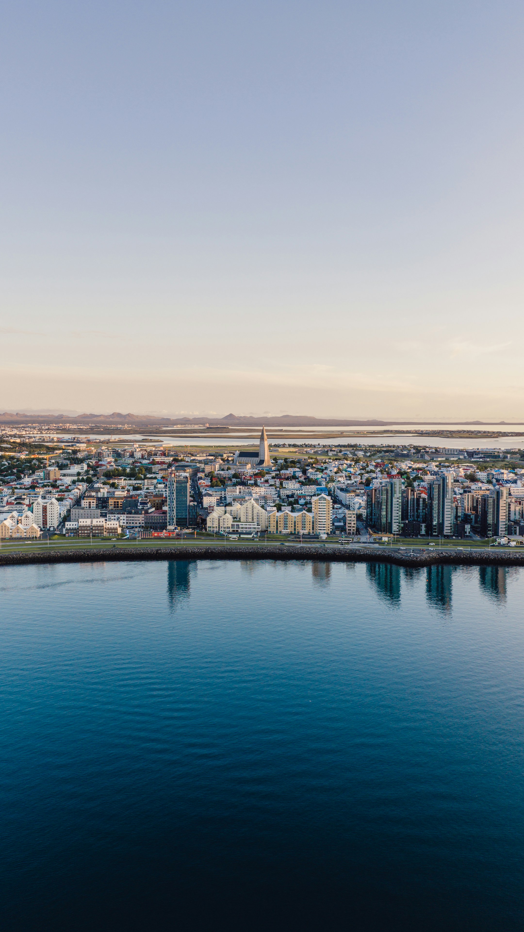 Edge of the Horizon: Cityscape Meeting Calm Water