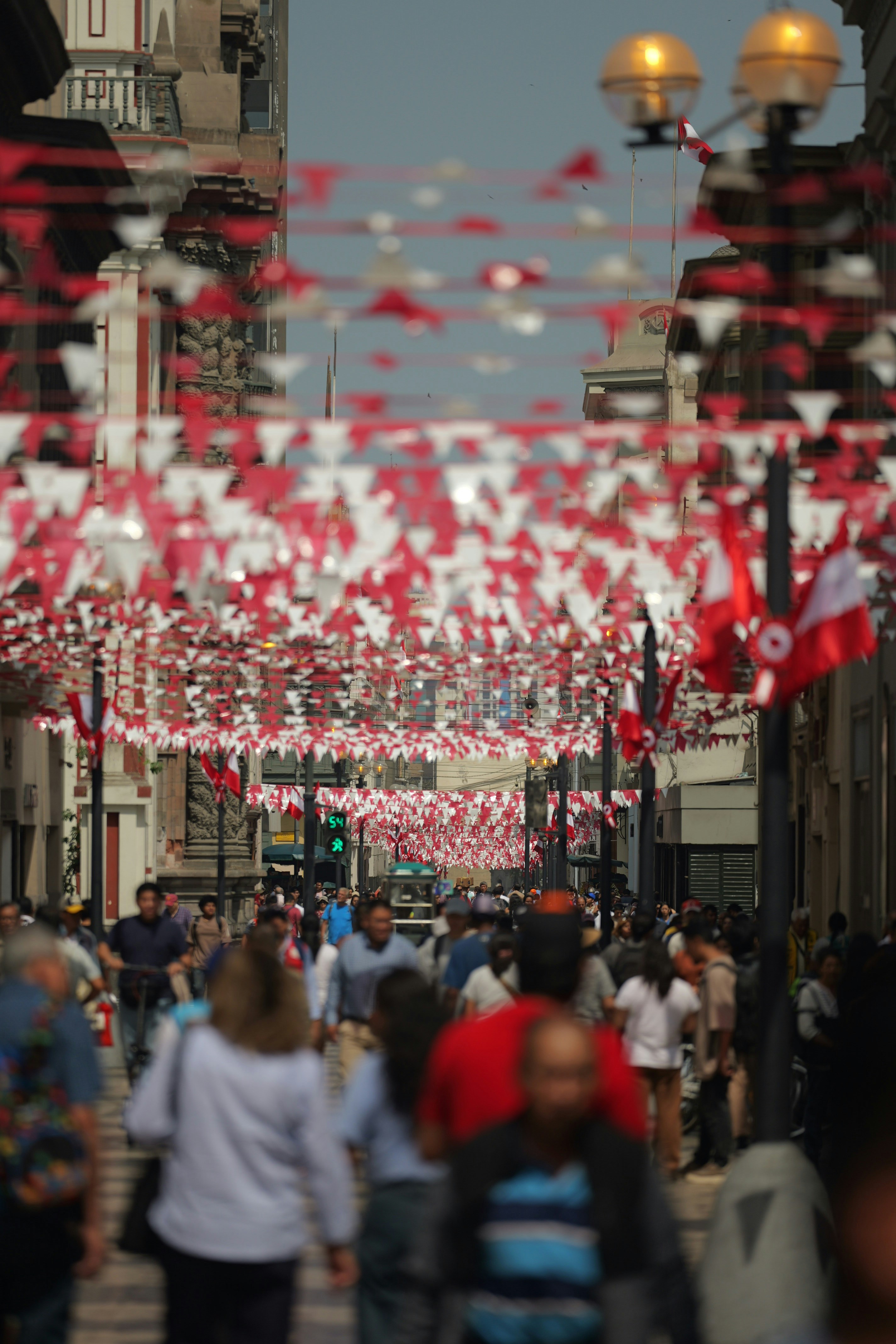 Streetside Festoon: A Sea of Red and White Amid Weekend Parade