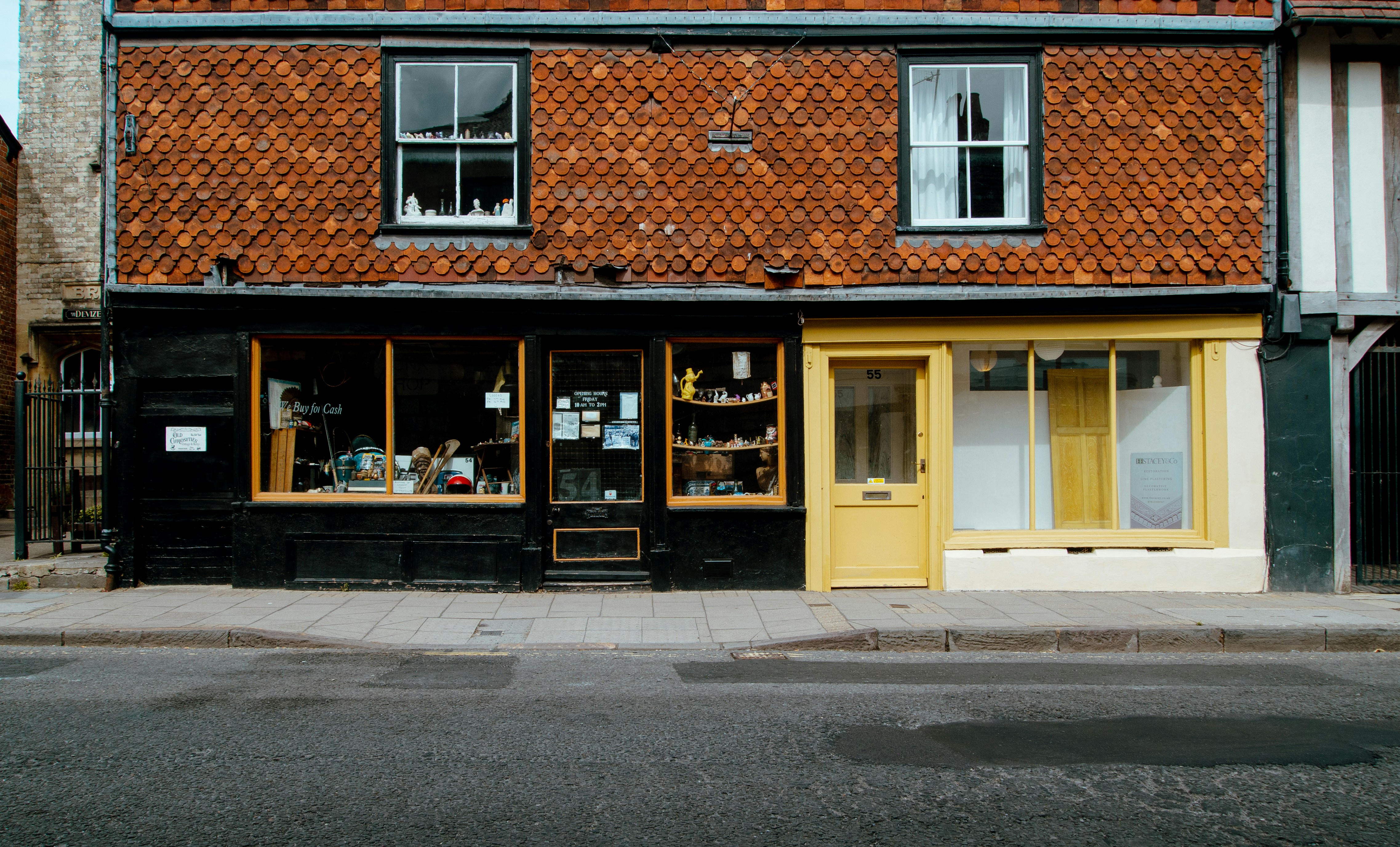Shopfront Mosaic: Brick Upper, Black Facade, Golden Door