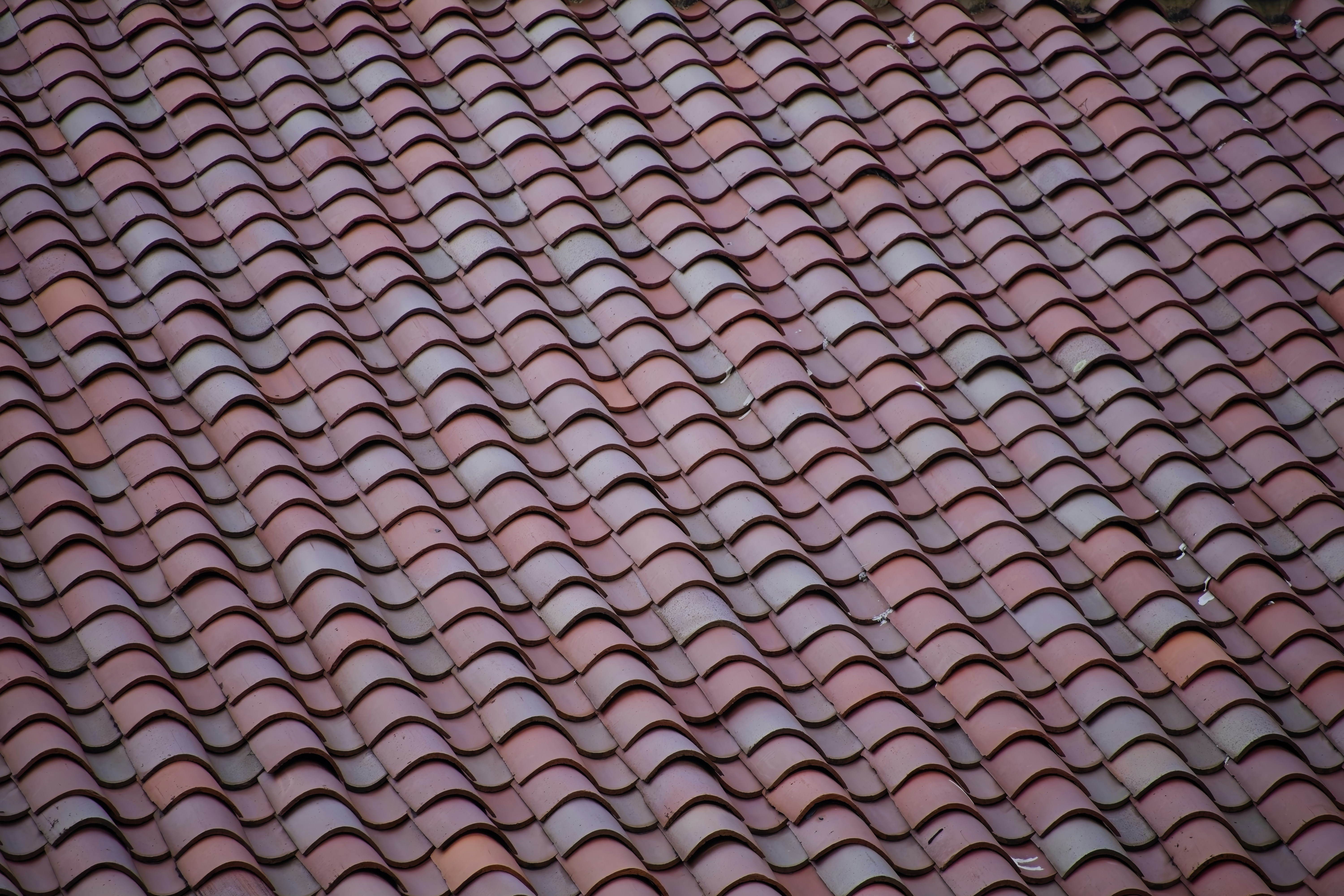 Red Tile Tapestry: A Close-Up of Weathered Roof Shingle Rows