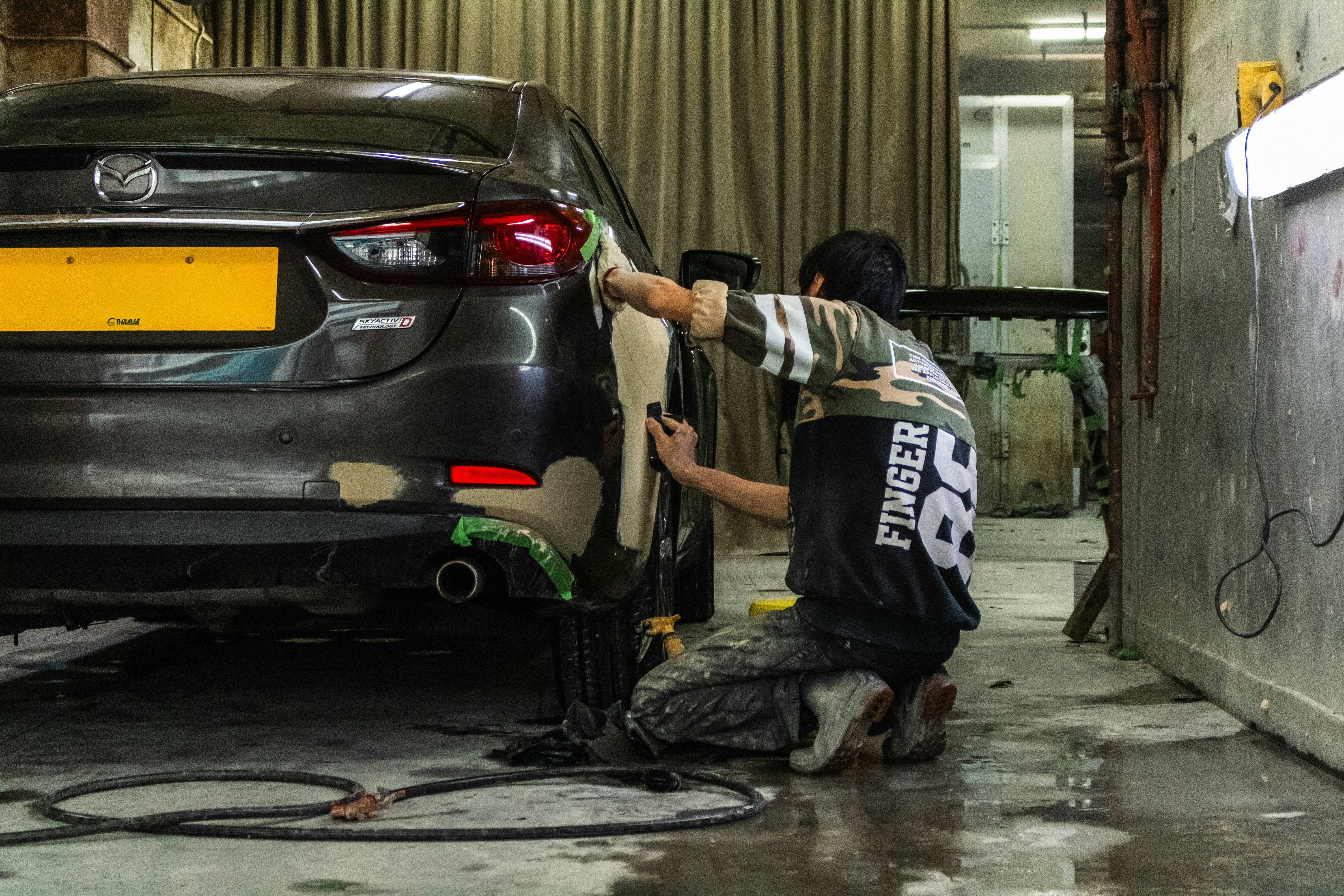 Grinder's Grit: Tire, Tools, and Tailpipe in a Dim Workshop
