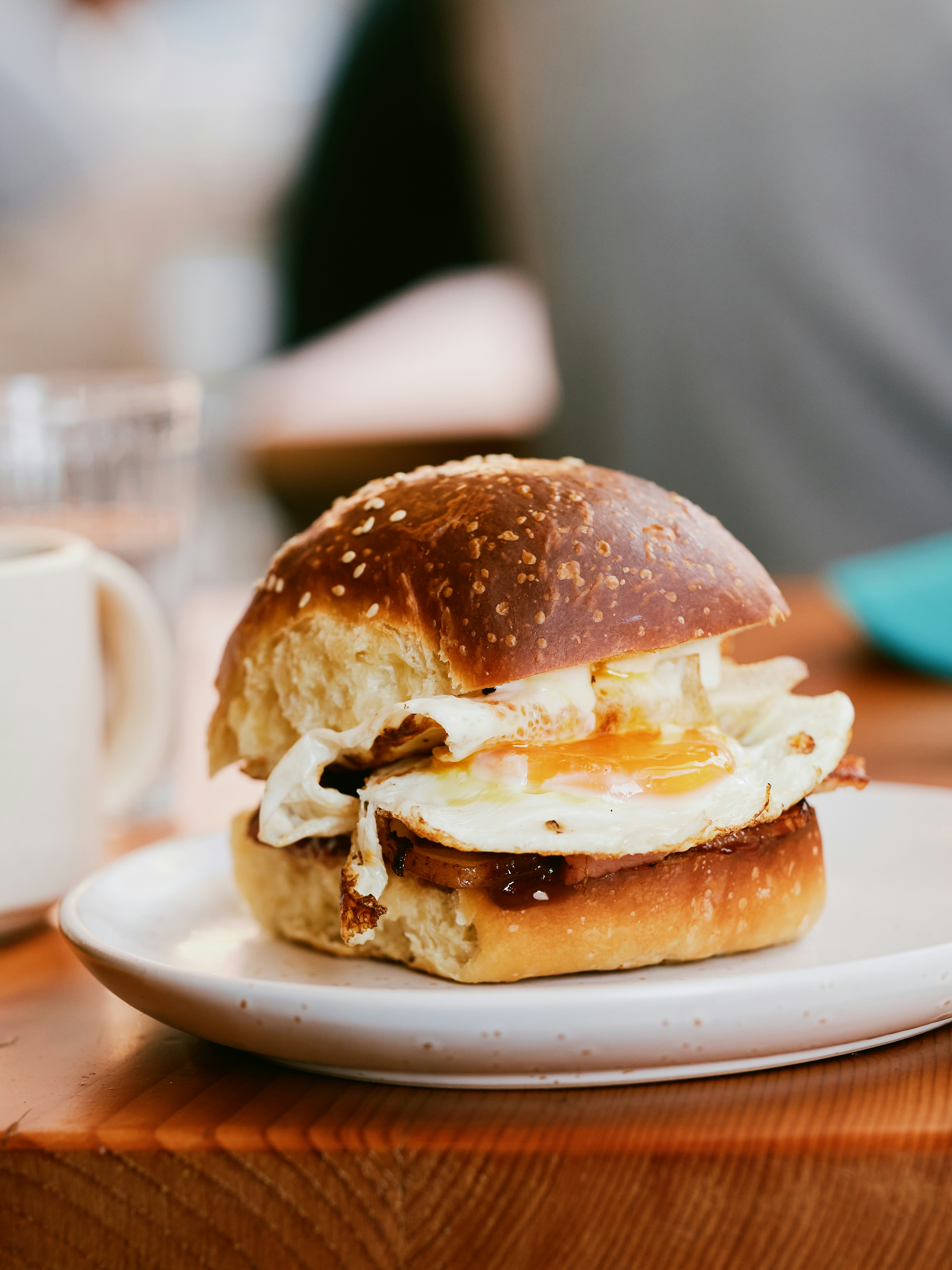 Stacked Gourmet: A Sunny Burger Moment on a Wooden Table